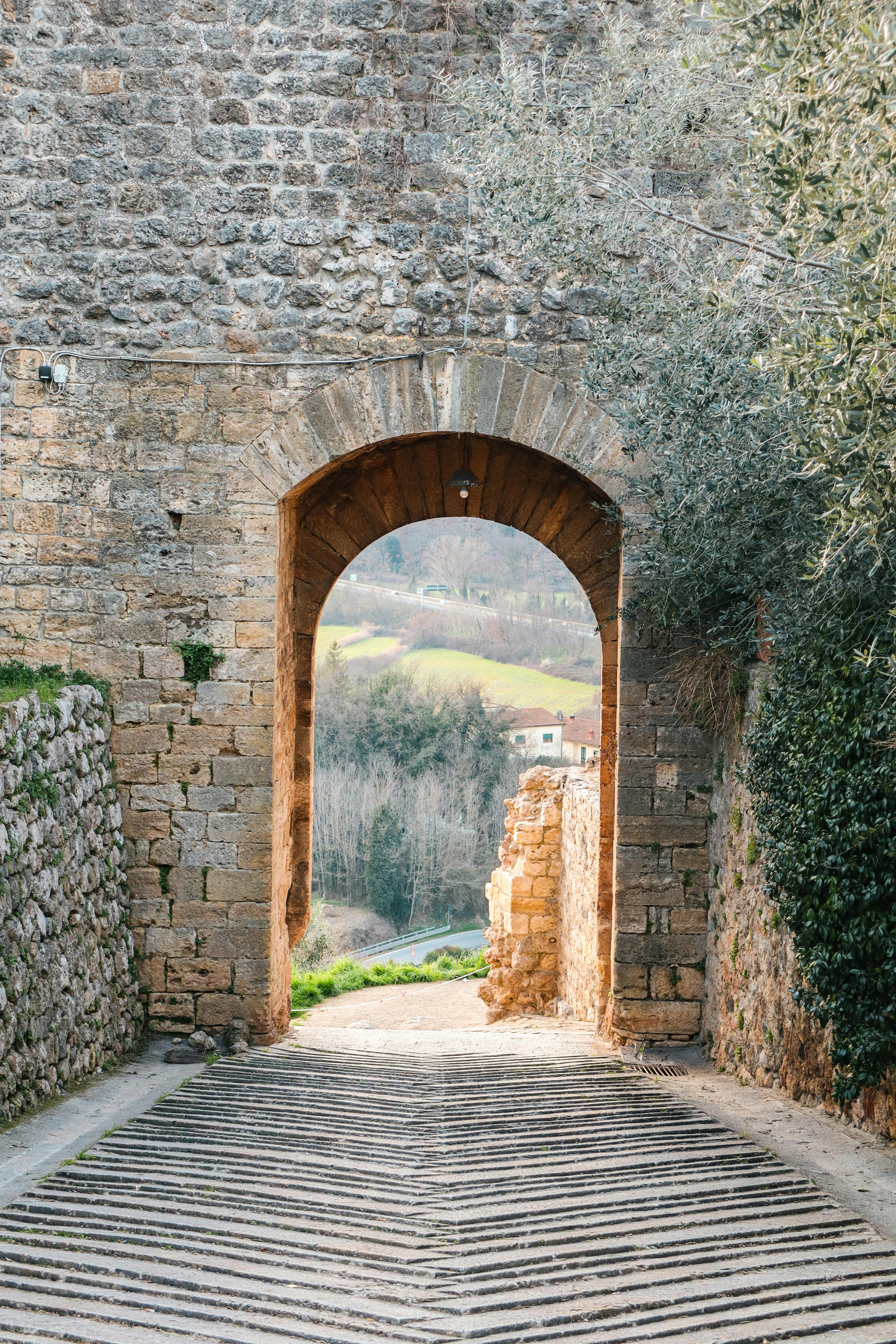 Ancient Stone Archway Overlooking Scenic Countryside · Free Stock Photo