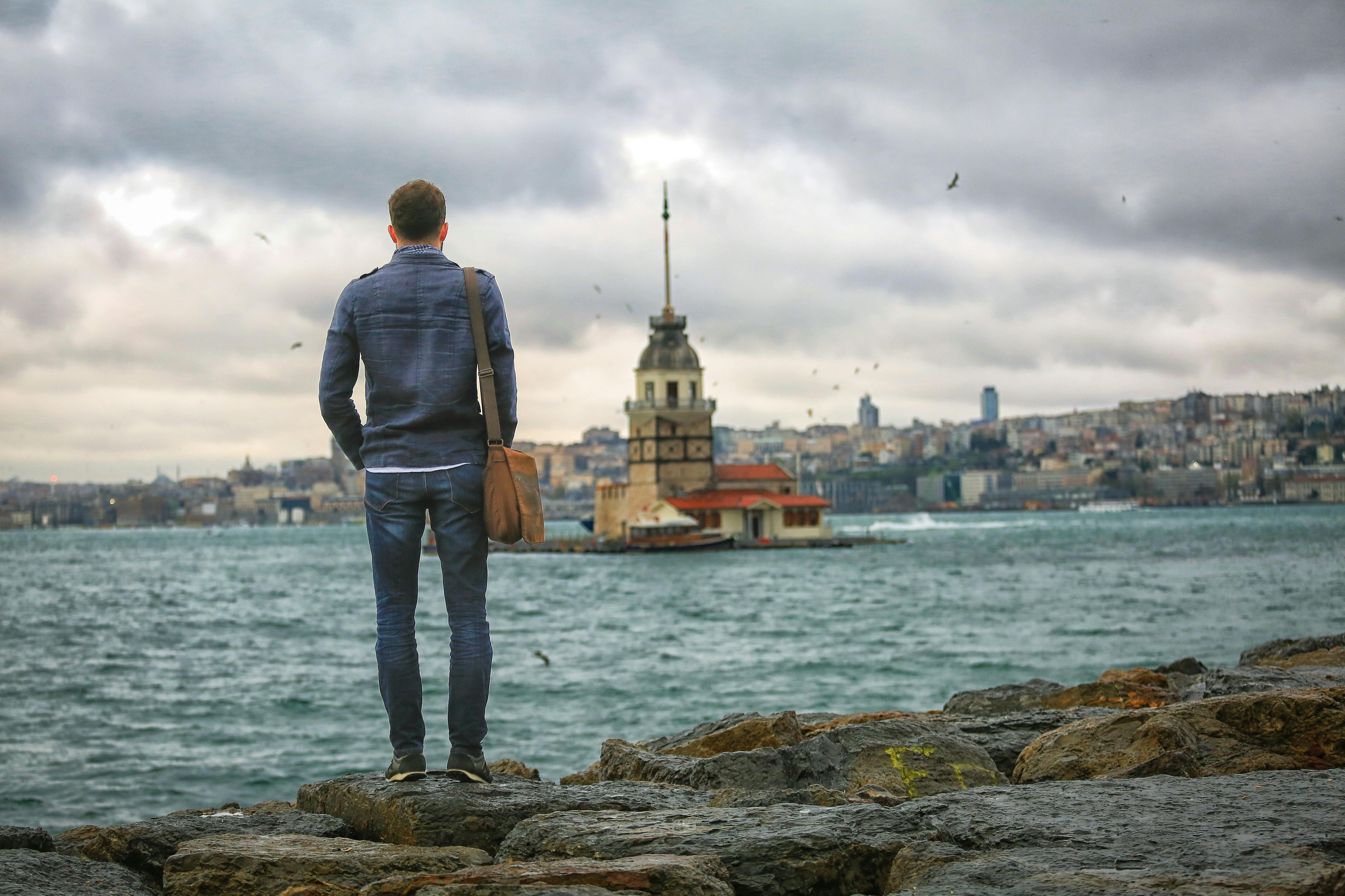 Lonely Figure Observing Maiden's Tower in İstanbul · Free Stock Photo