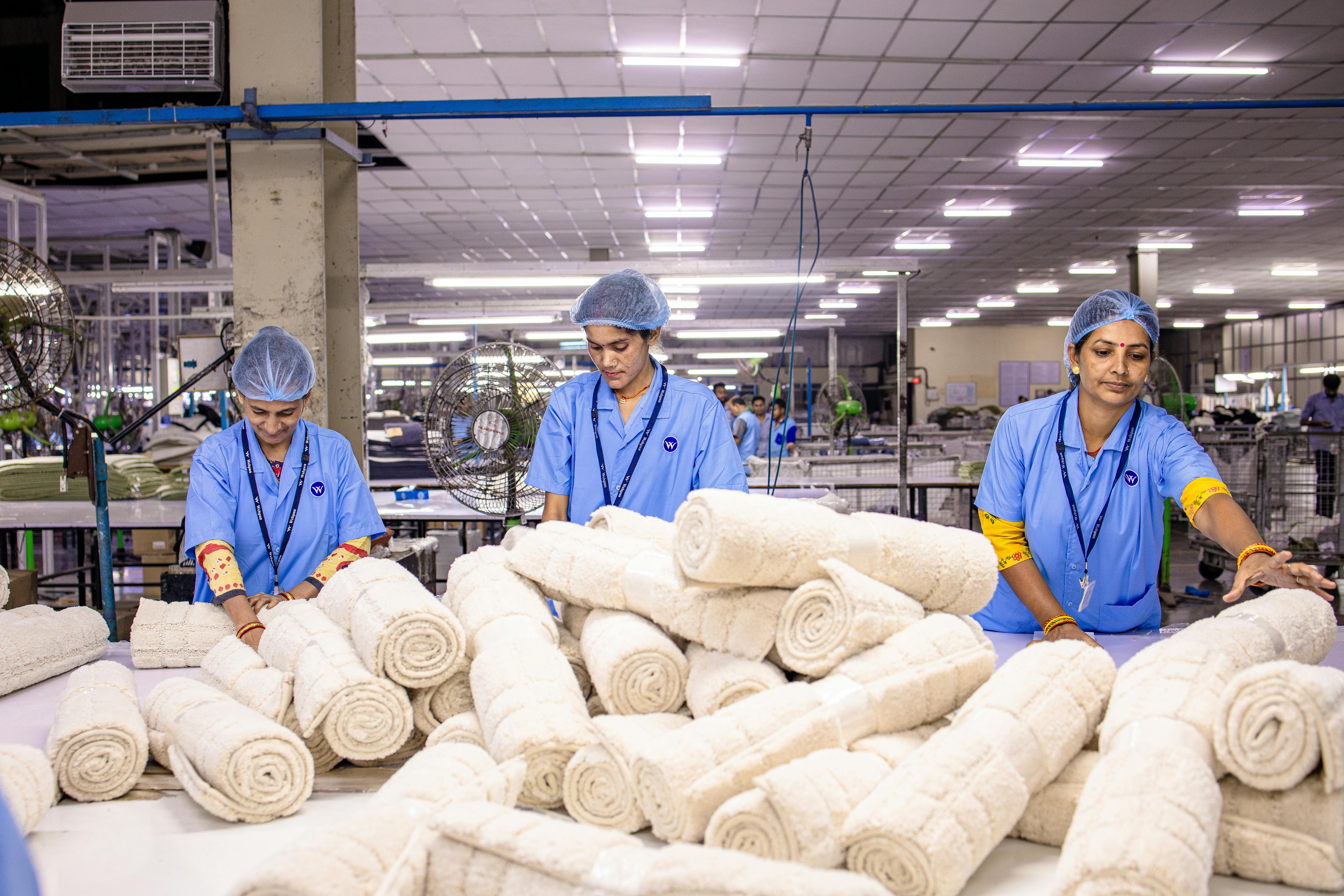 Textile Factory Workers Preparing Rolled Fabric · Free Stock Photo