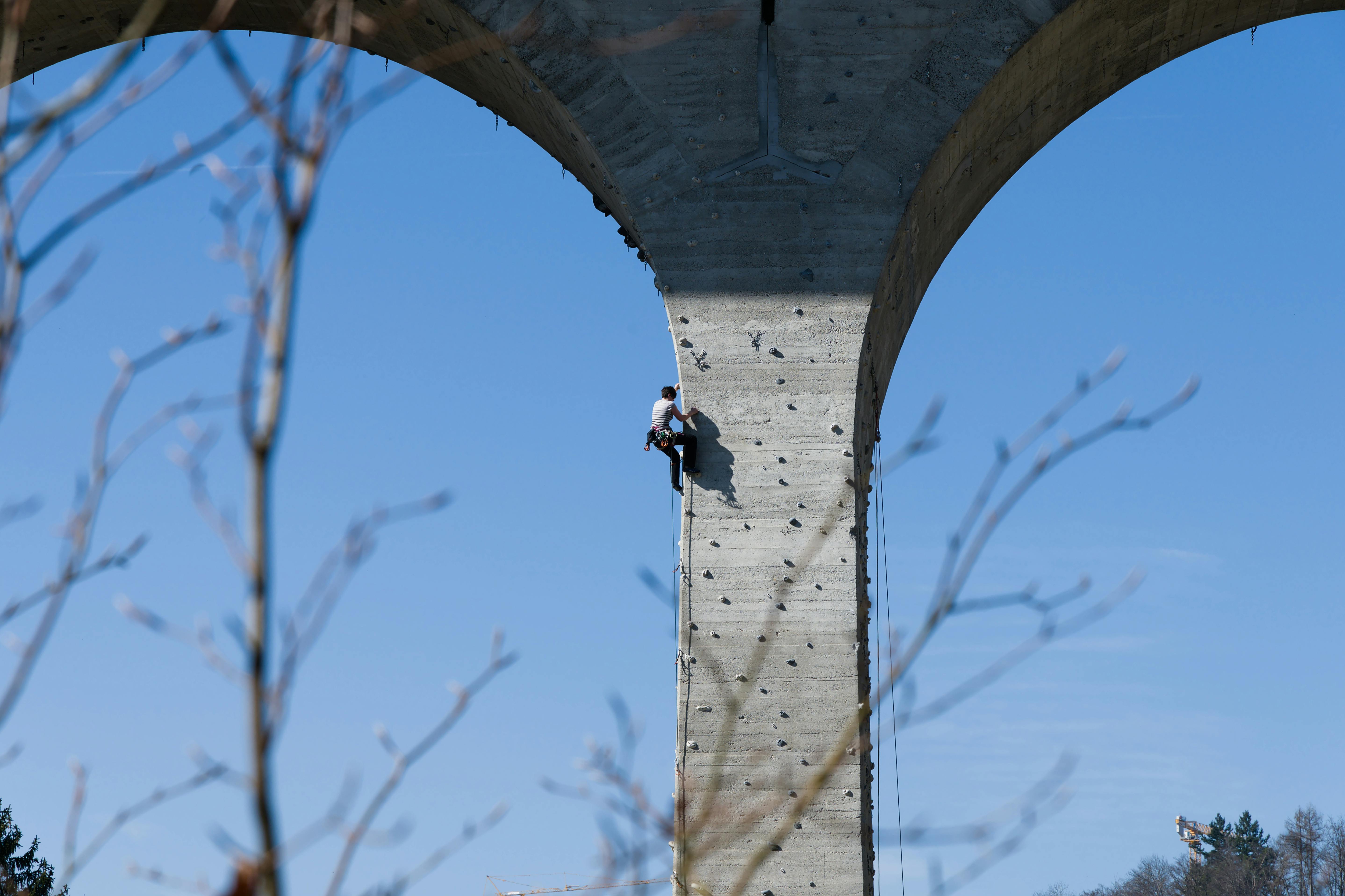 Man Rock Climbing on Concrete Bridge Outdoors · Free Stock Photo