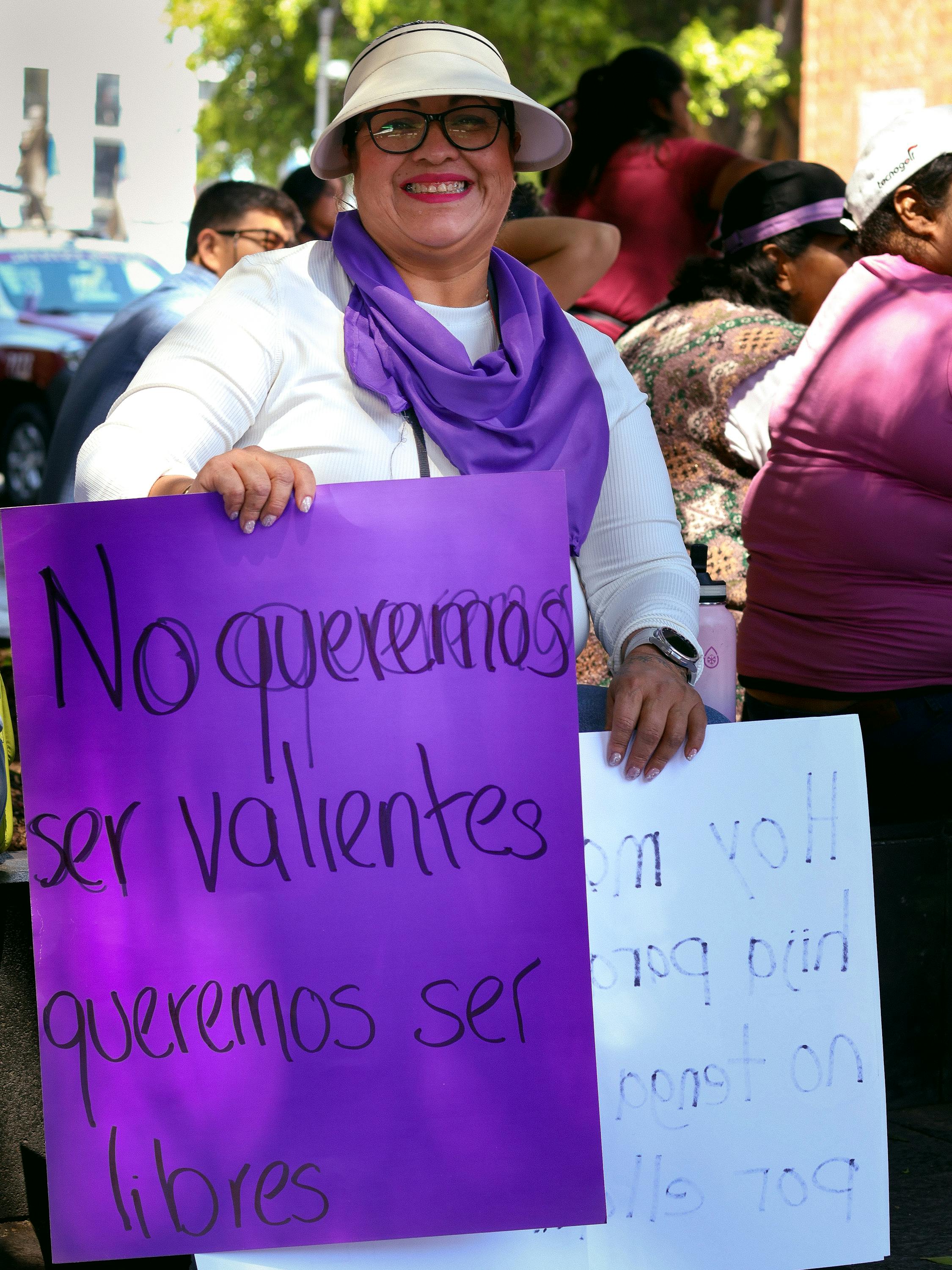 Woman Holding Protest Signs at Outdoor Rally · Free Stock Photo