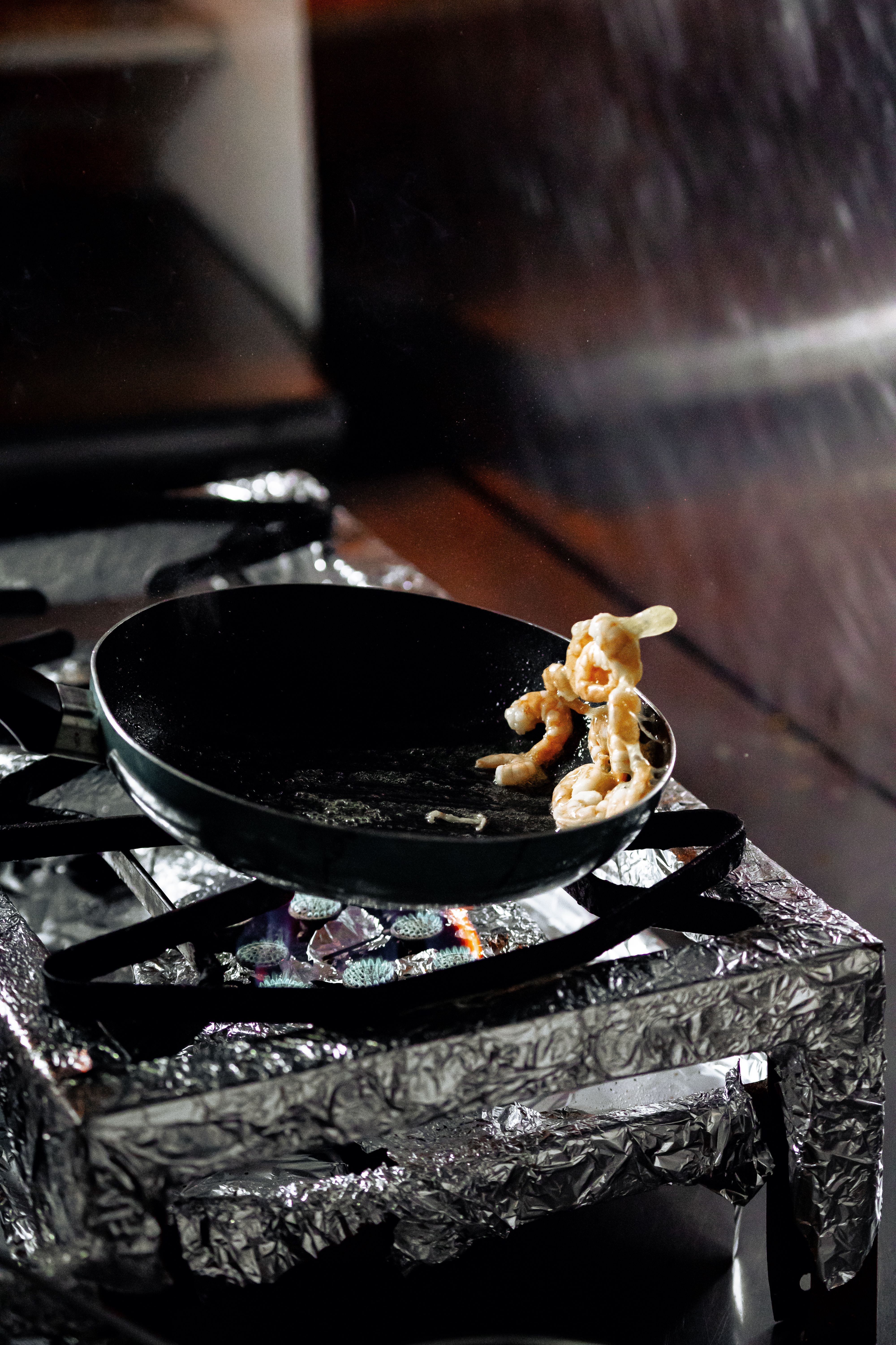Sizzling Seafood in Frying Pan on Gas Stove · Free Stock Photo