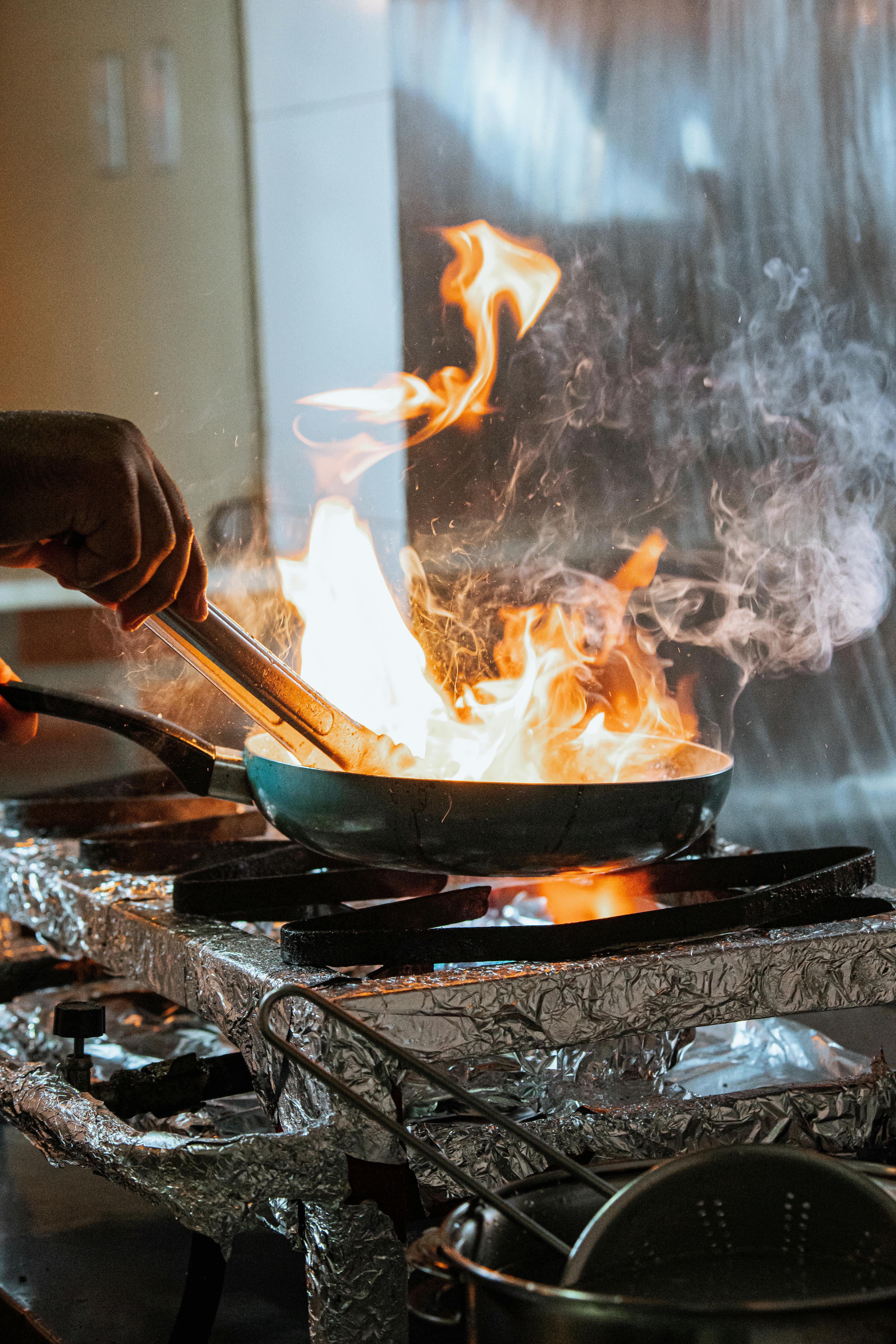 Chef Sautéing Dish with Dramatic Flames · Free Stock Photo