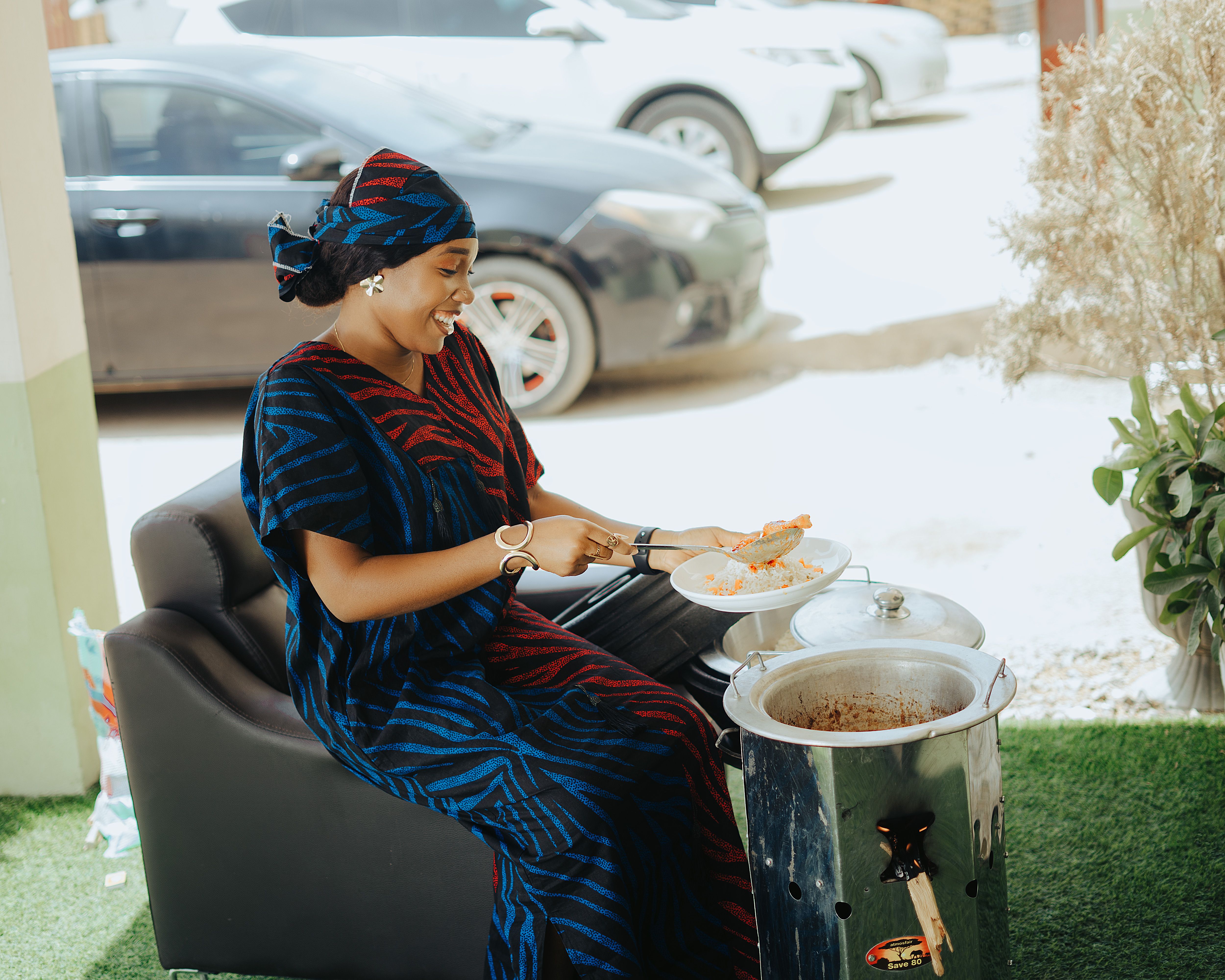African woman cooking traditional meal outdoors · Free Stock Photo
