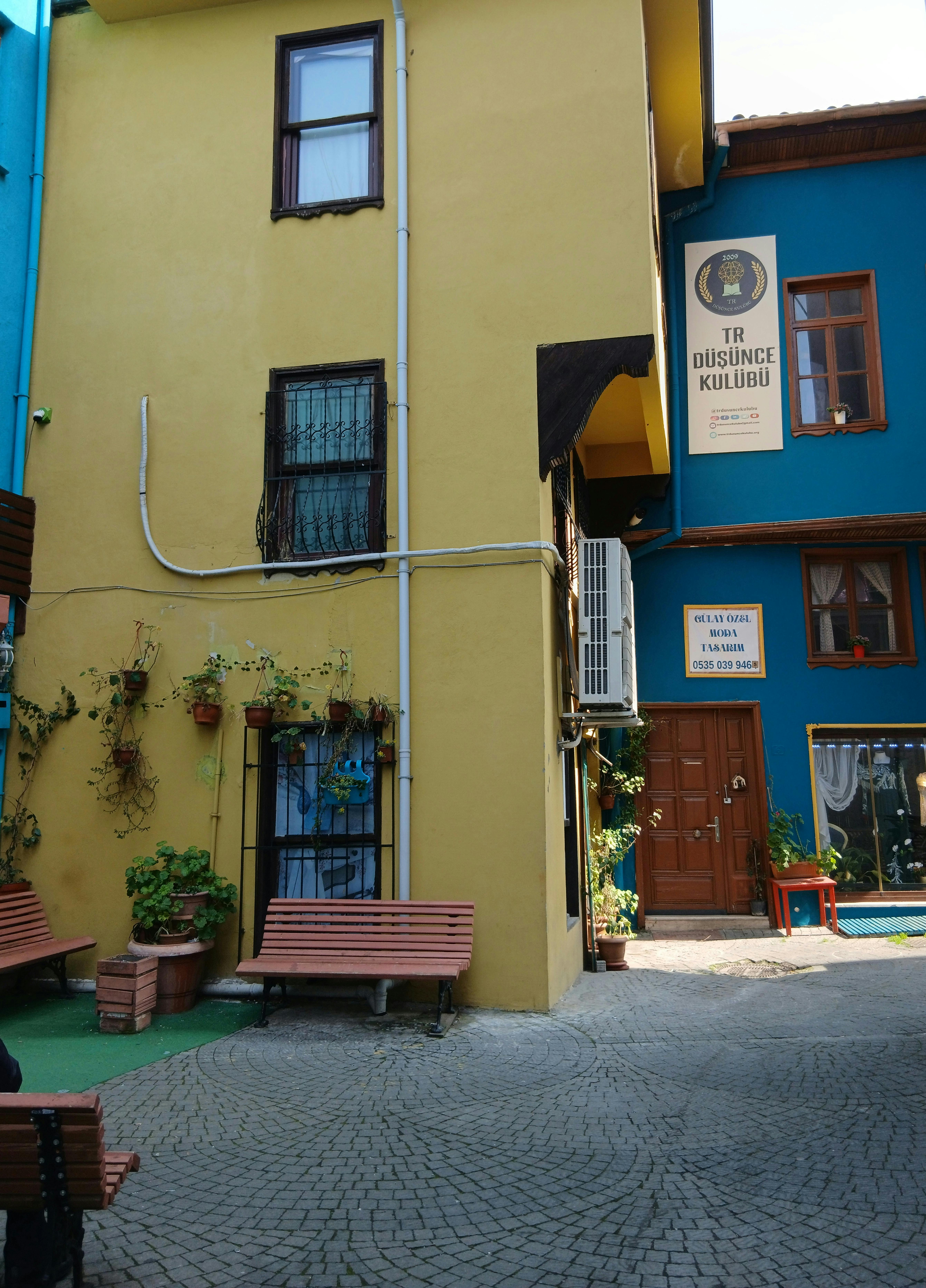 Colorful Courtyard with Yellow and Blue Building · Free Stock Photo