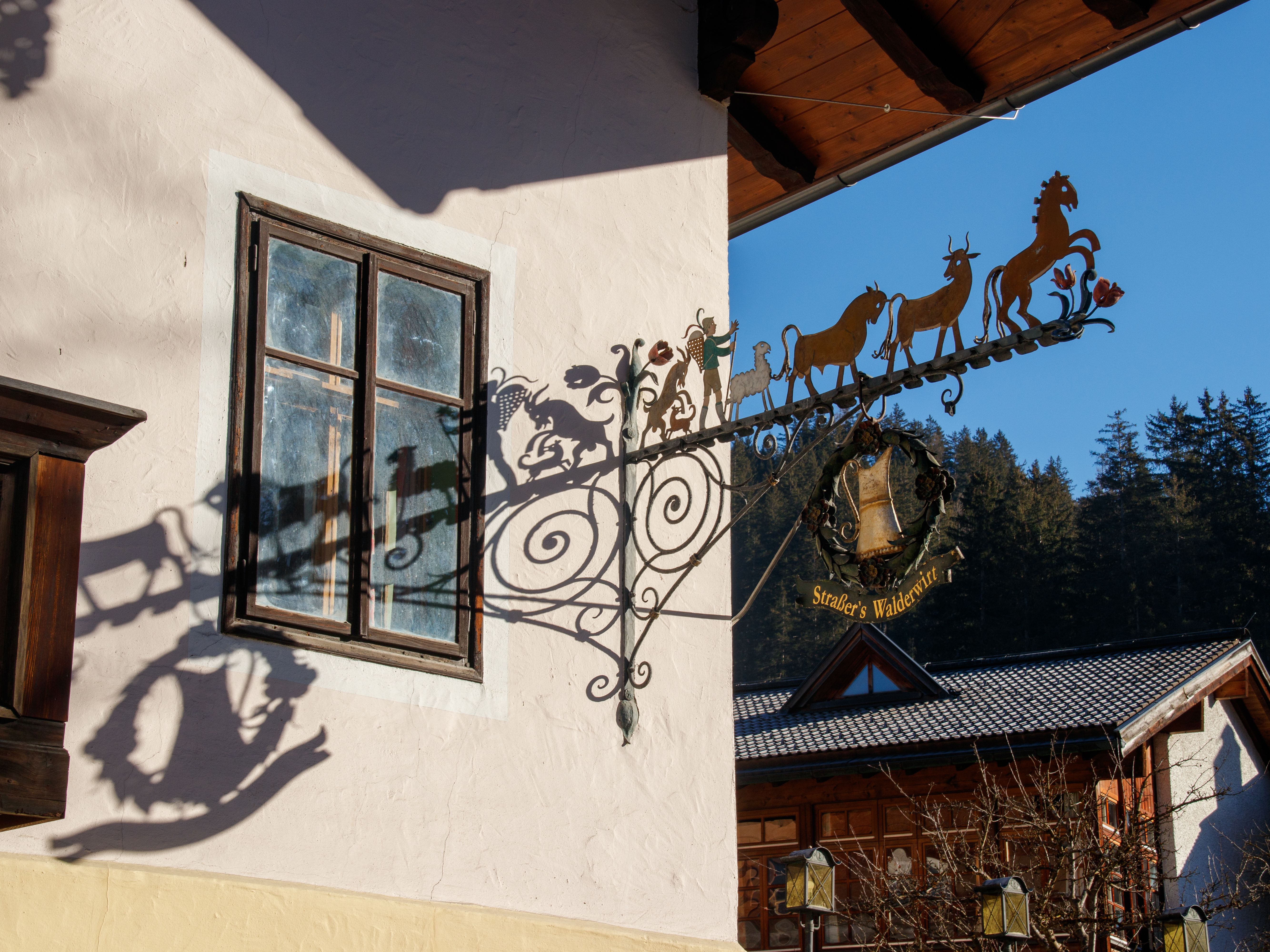 Decorative Iron Sign on Traditional European Building · Free Stock Photo