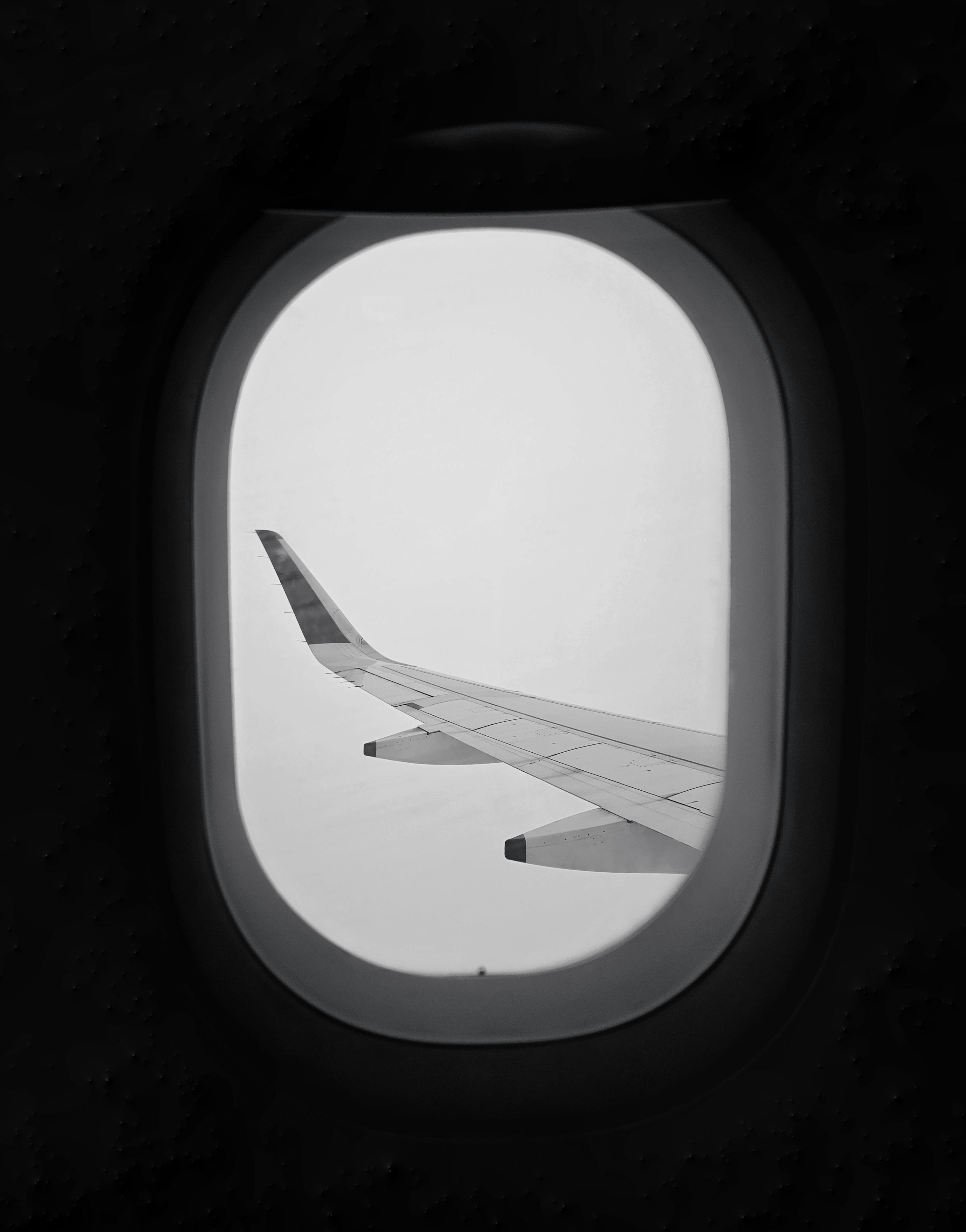 Aerial View of Airplane Wing Through Window · Free Stock Photo