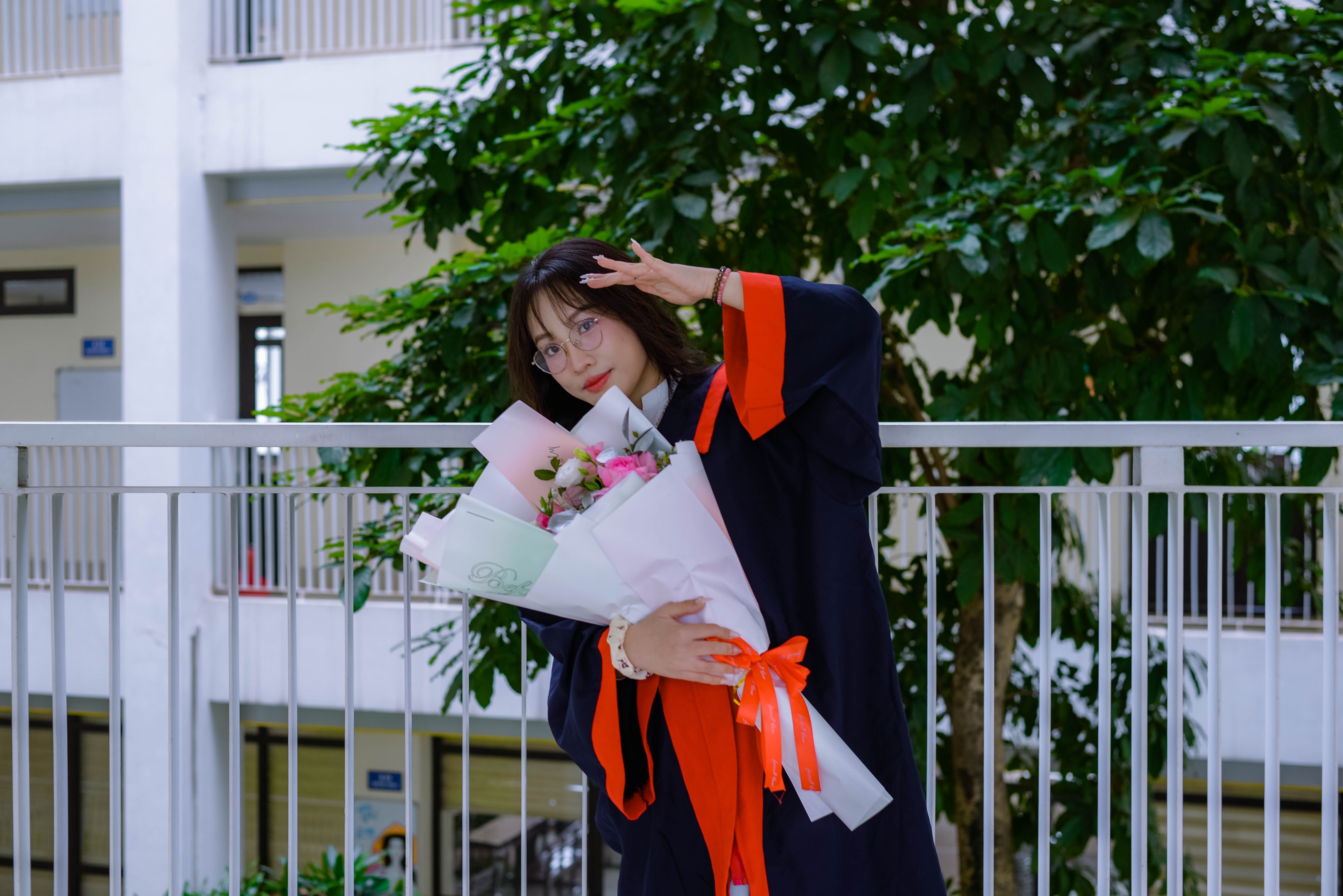 Graduation Celebration with Bouquet Outdoors · Free Stock Photo