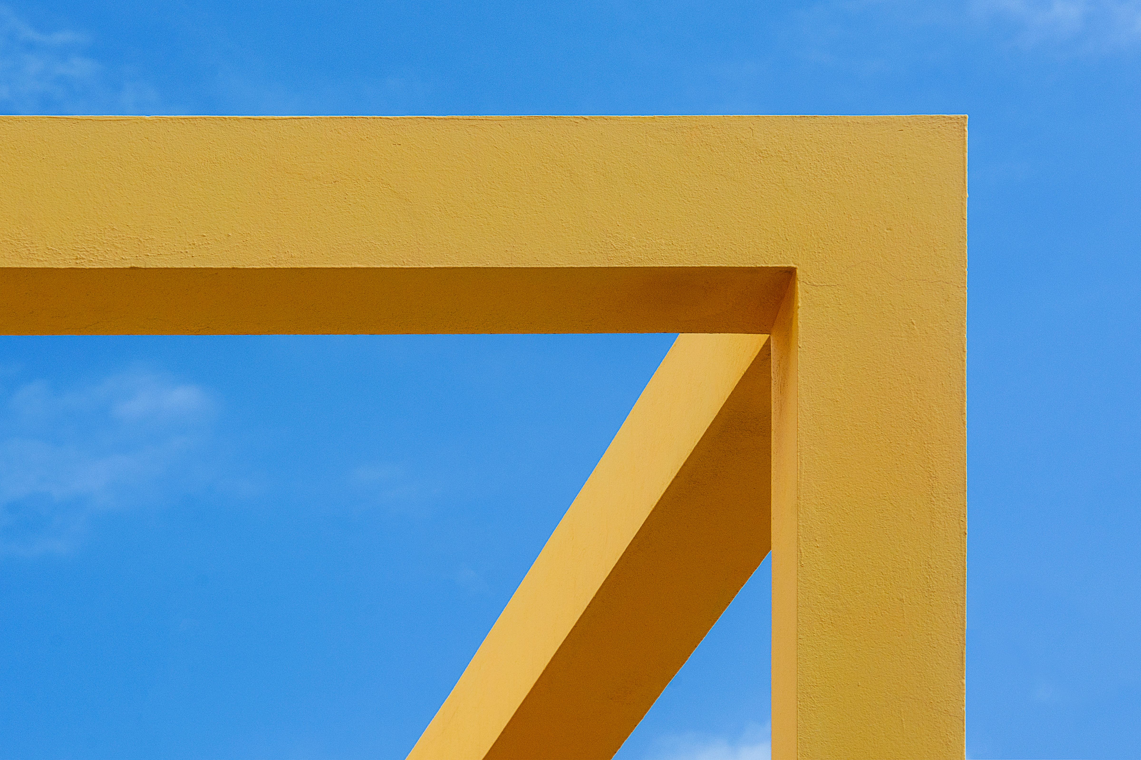 Geometric Yellow Structure Against Clear Sky · Free Stock Photo