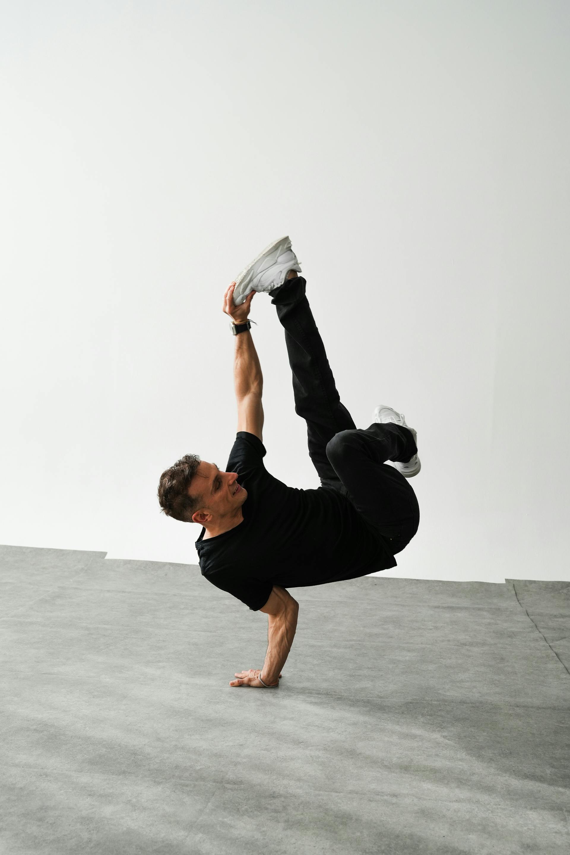 Dynamic Breakdance Pose in Minimalist Studio · Free Stock Photo