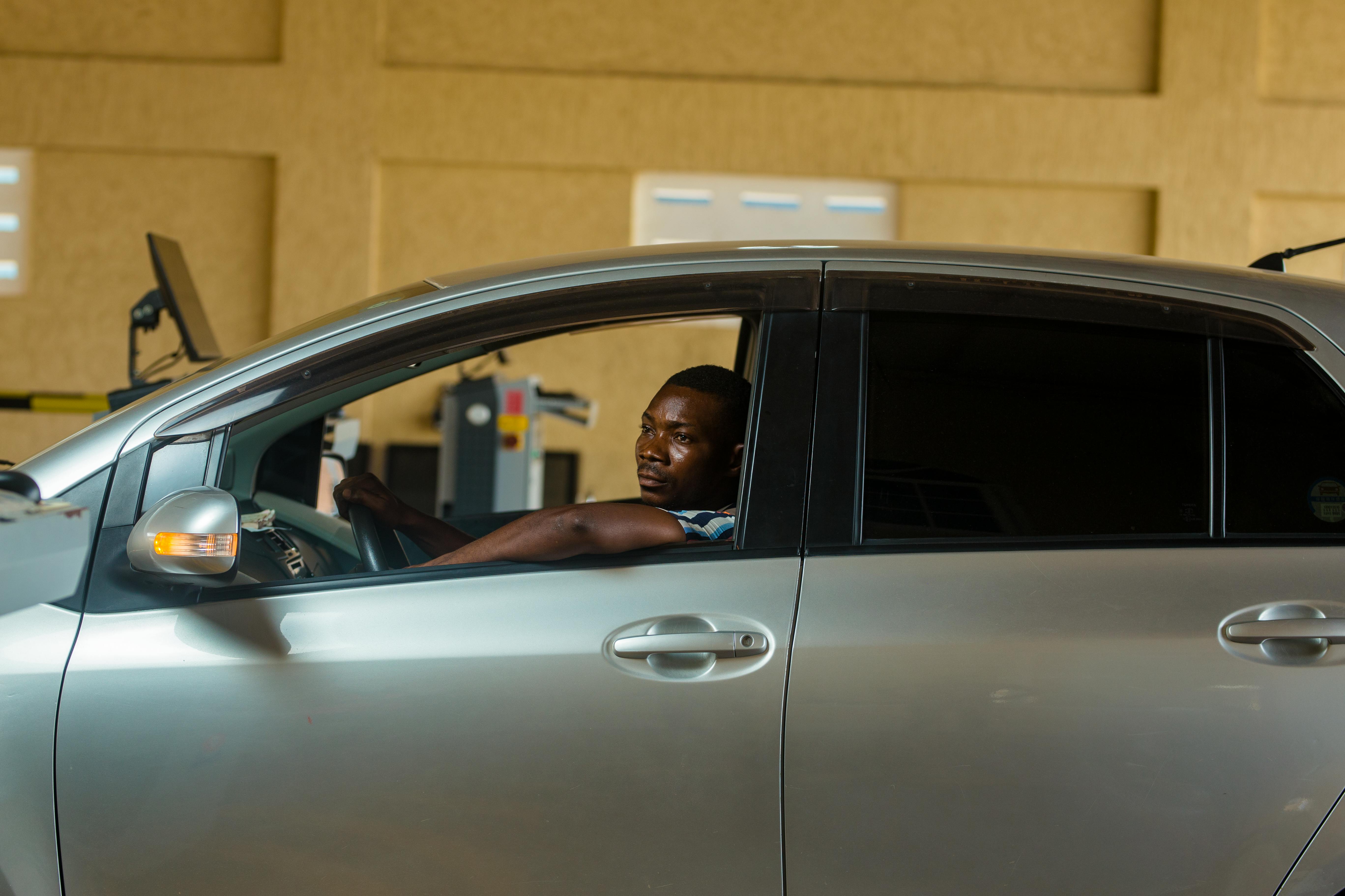 Driver Inside a Car During Inspection Process · Free Stock Photo