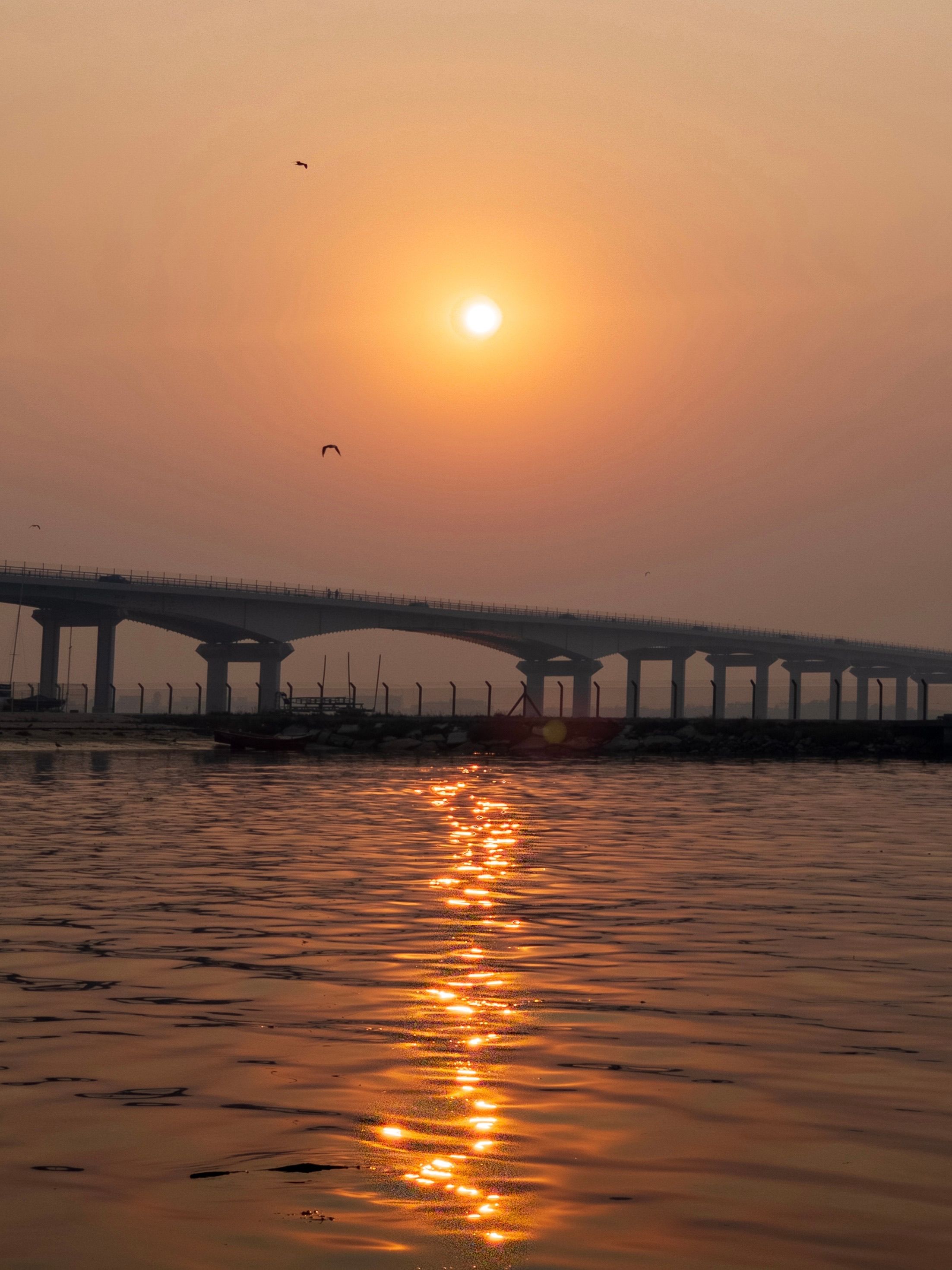 Sunrise over Coastal Bridge with Reflective Waters · Free Stock Photo