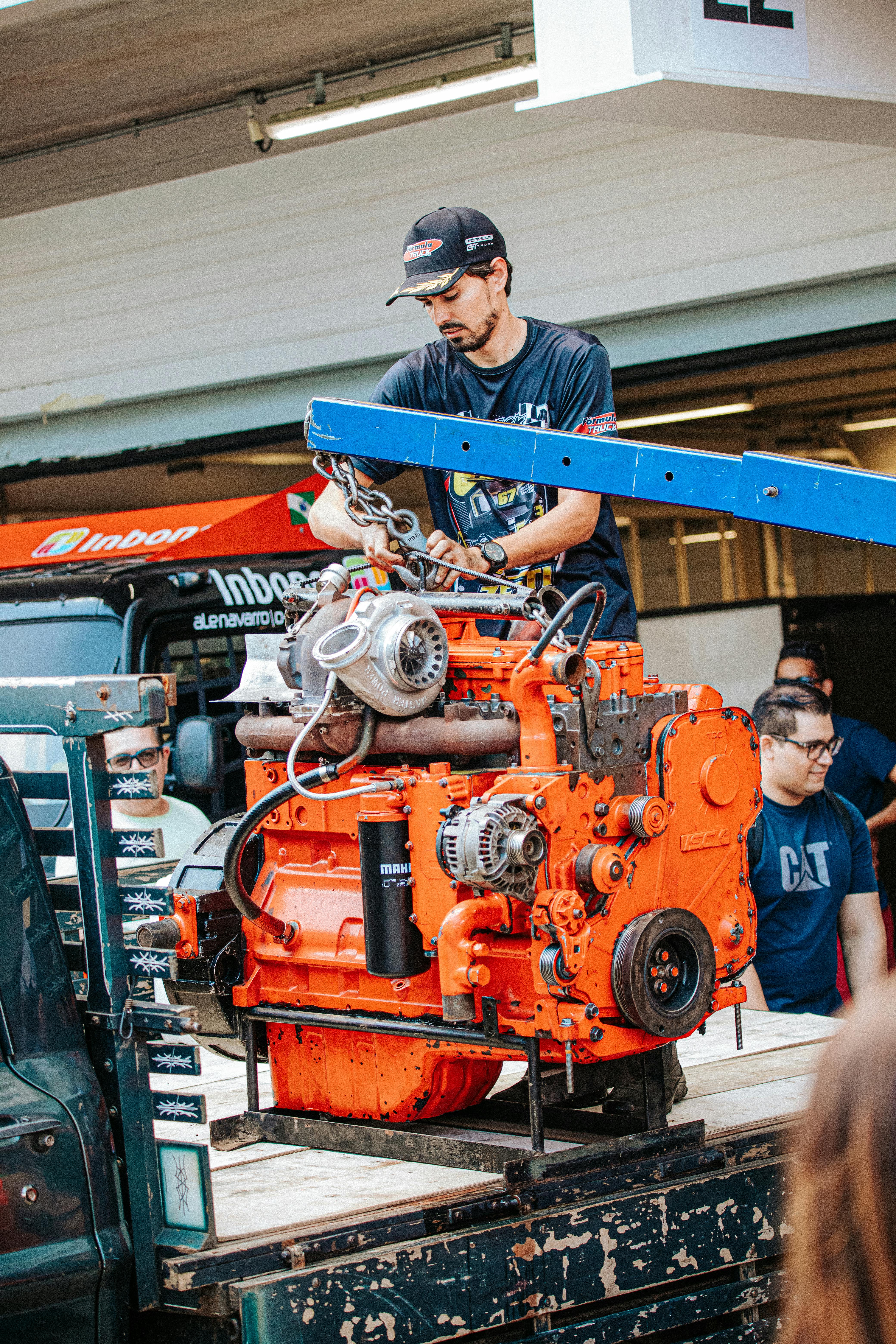 Mechanic Operating Heavy Machinery Engine in São Paulo · Free Stock Photo