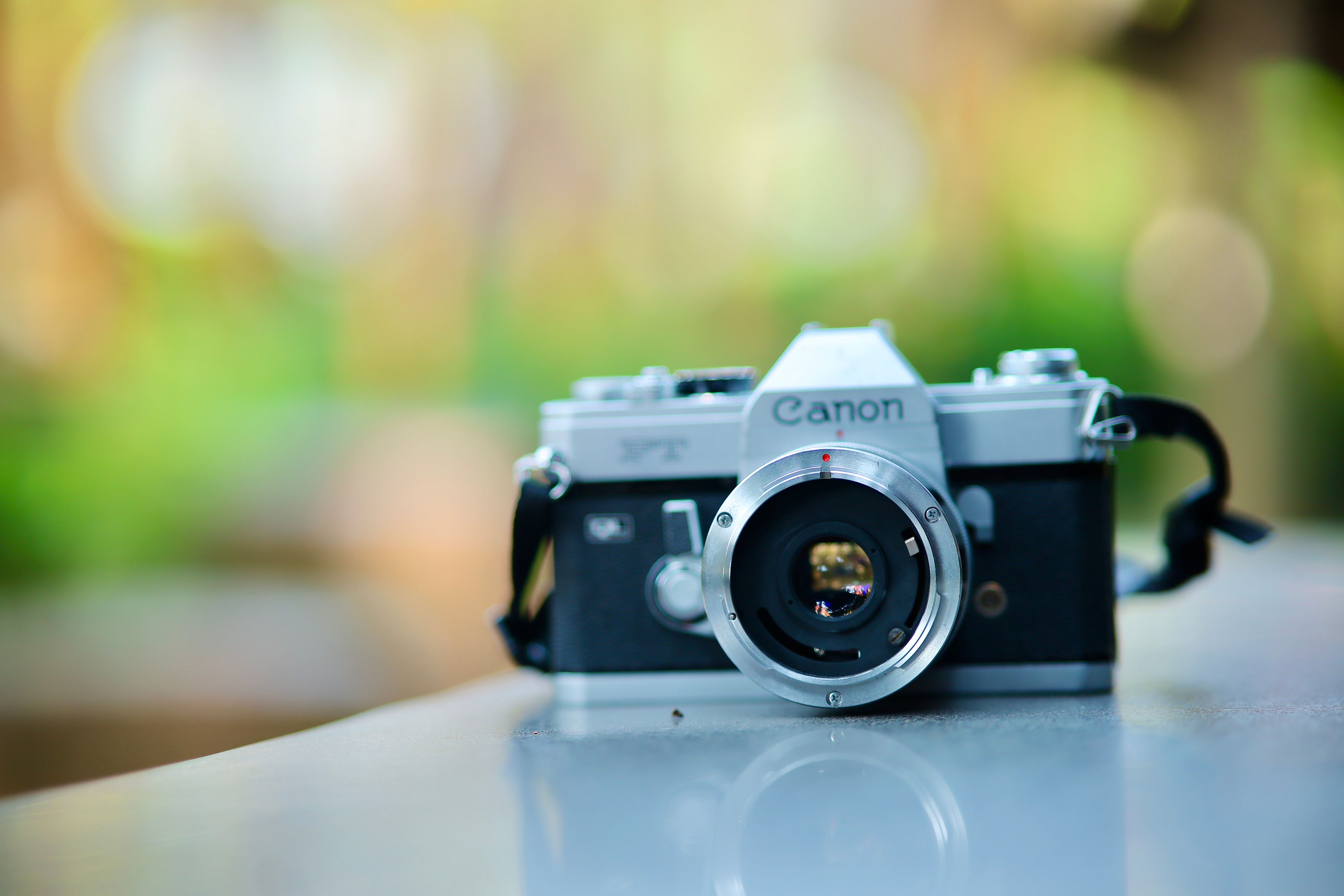 Silver and Black Shallow Focus Camera on Table · Free Stock Photo