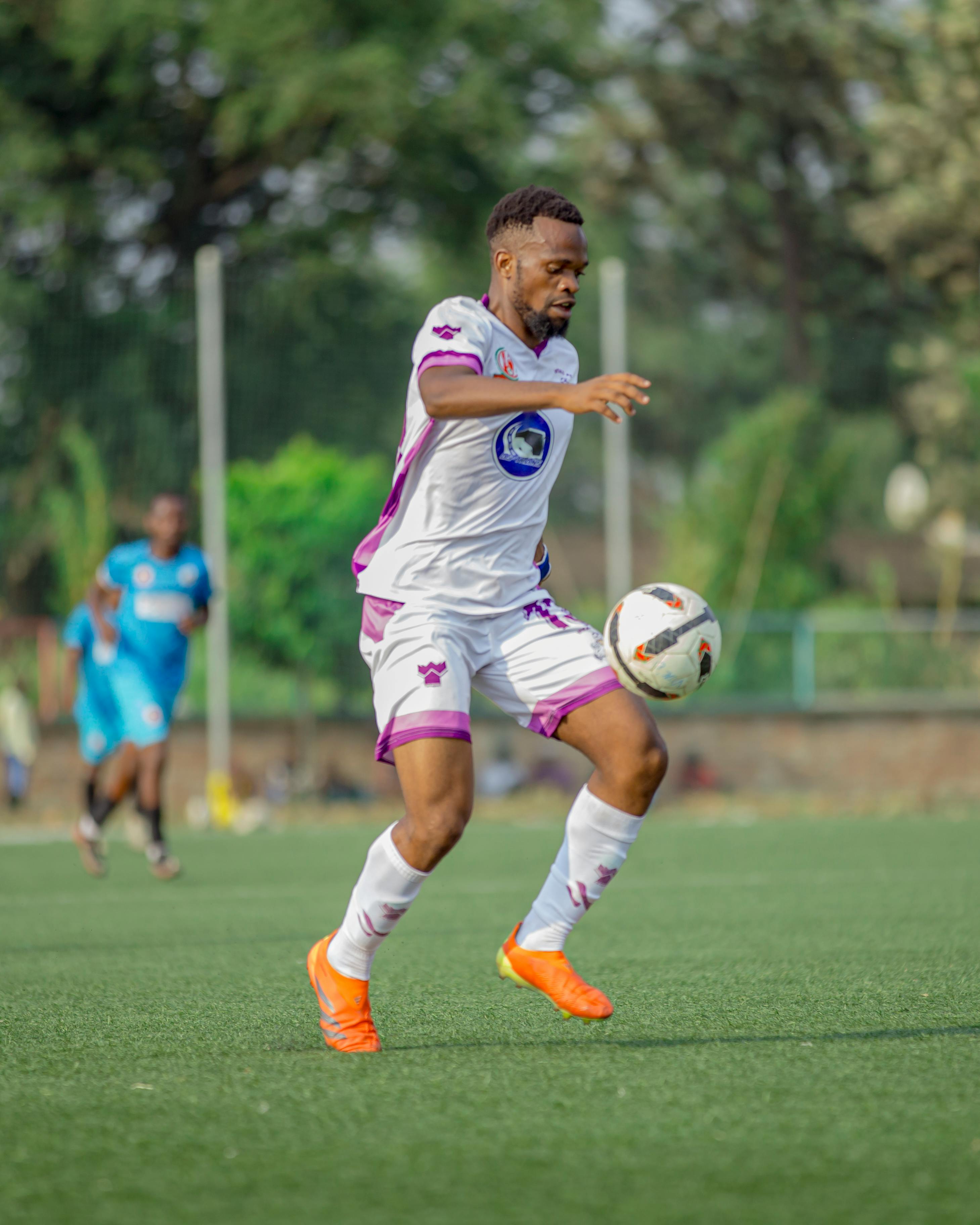 A Man Running on Football Field · Free Stock Photo