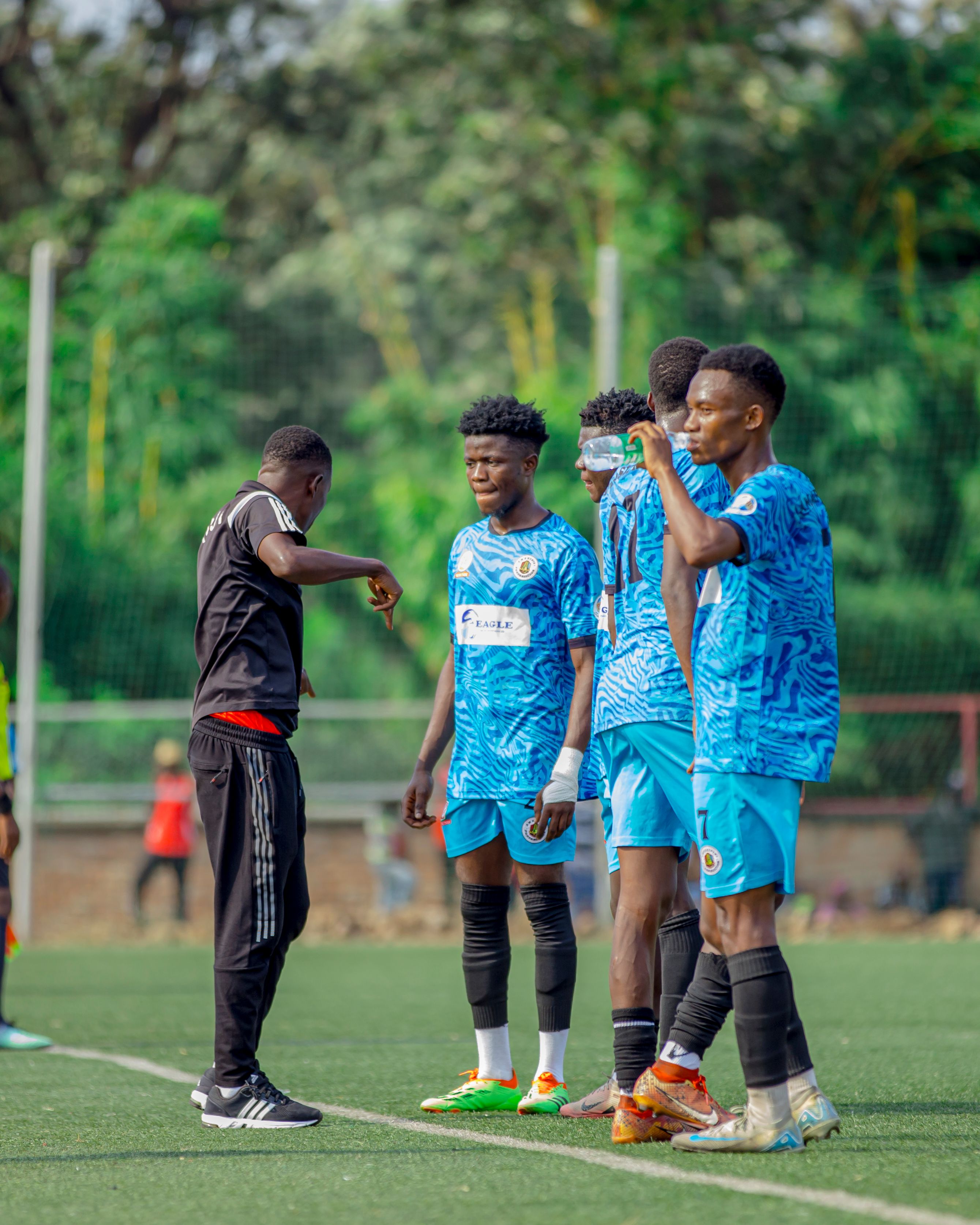 Soccer Team Strategy Session on Field · Free Stock Photo