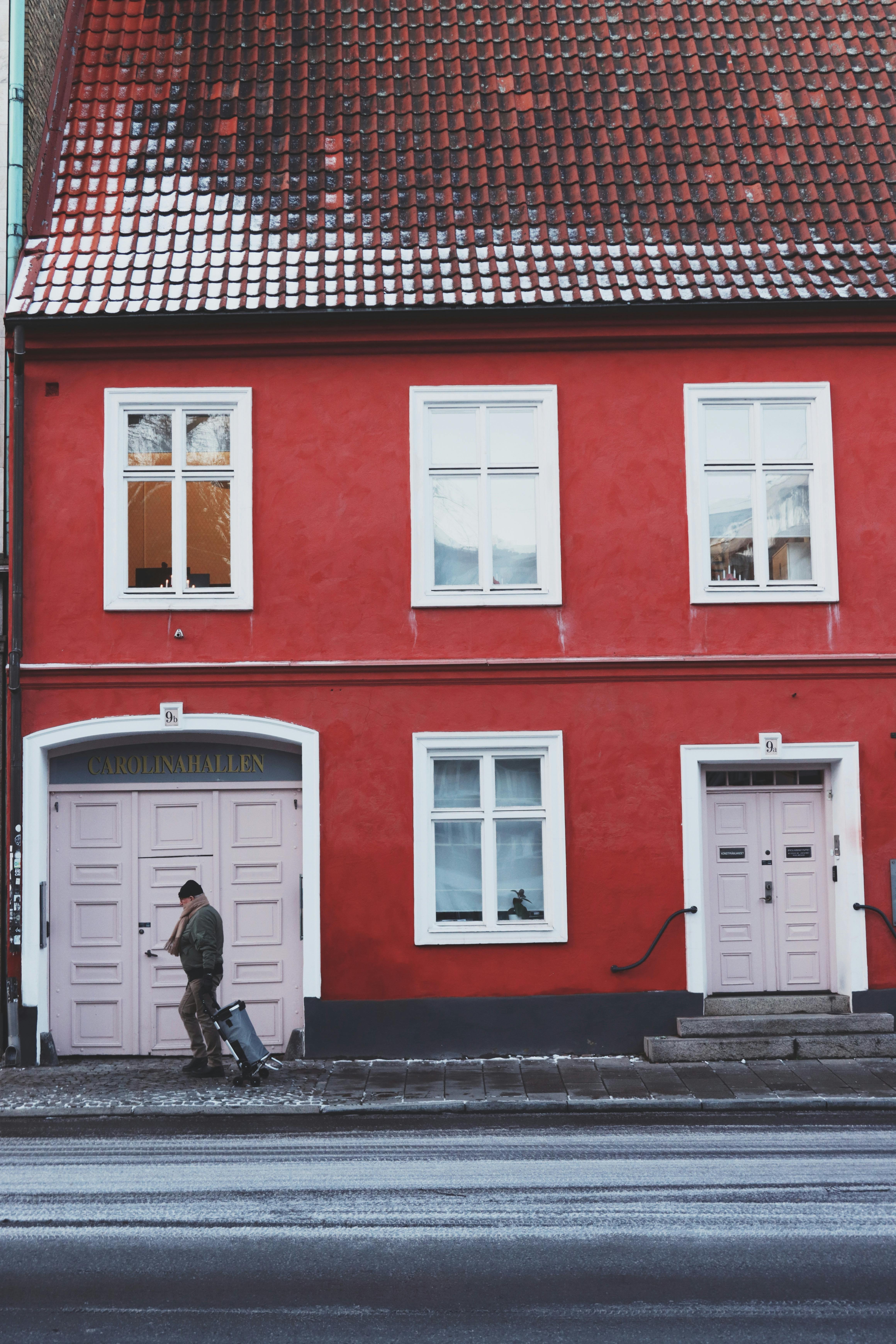 Charming Red Building in Malmö's Winter Street · Free Stock Photo