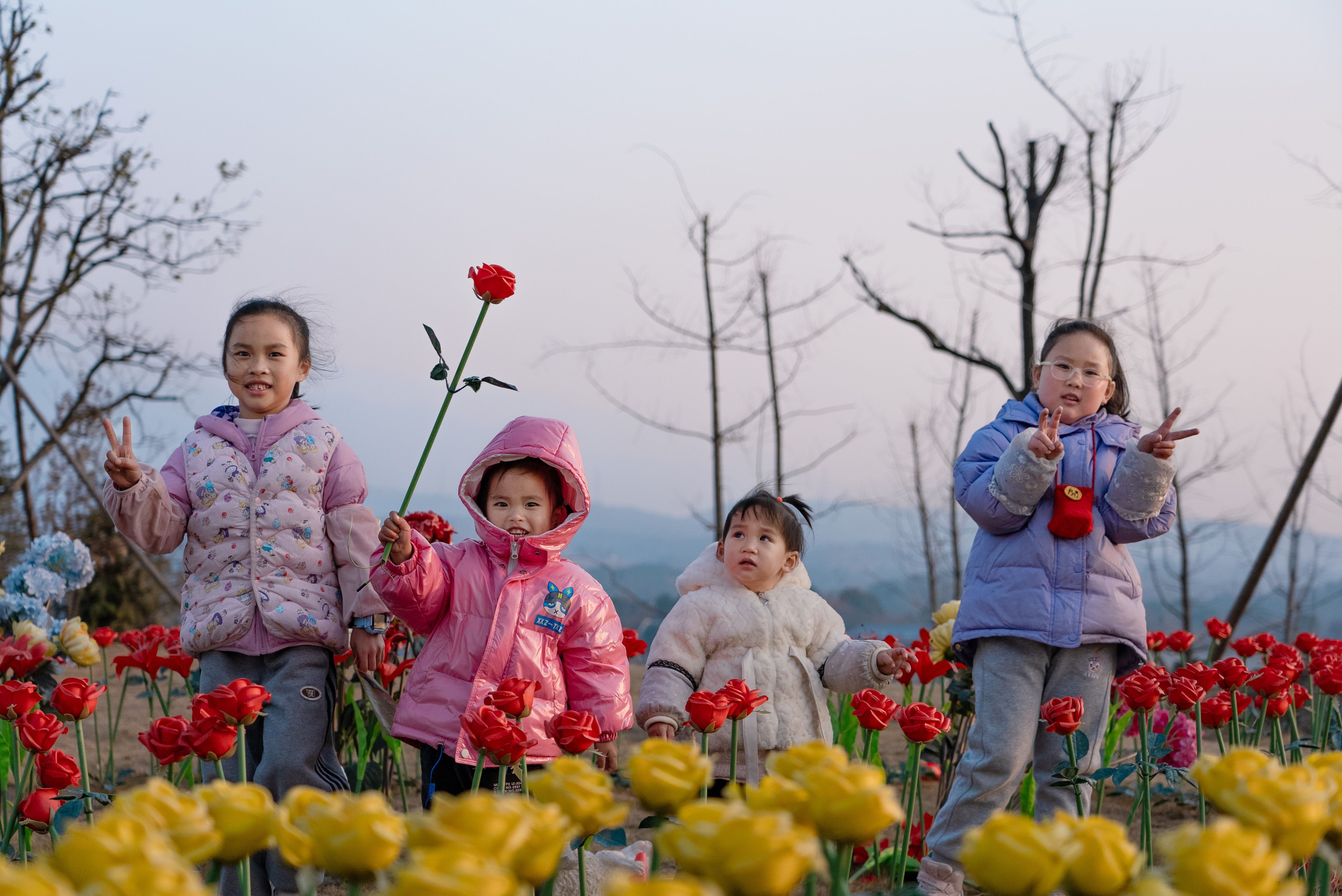 Children Posing in Colorful Flower Field · Free Stock Photo