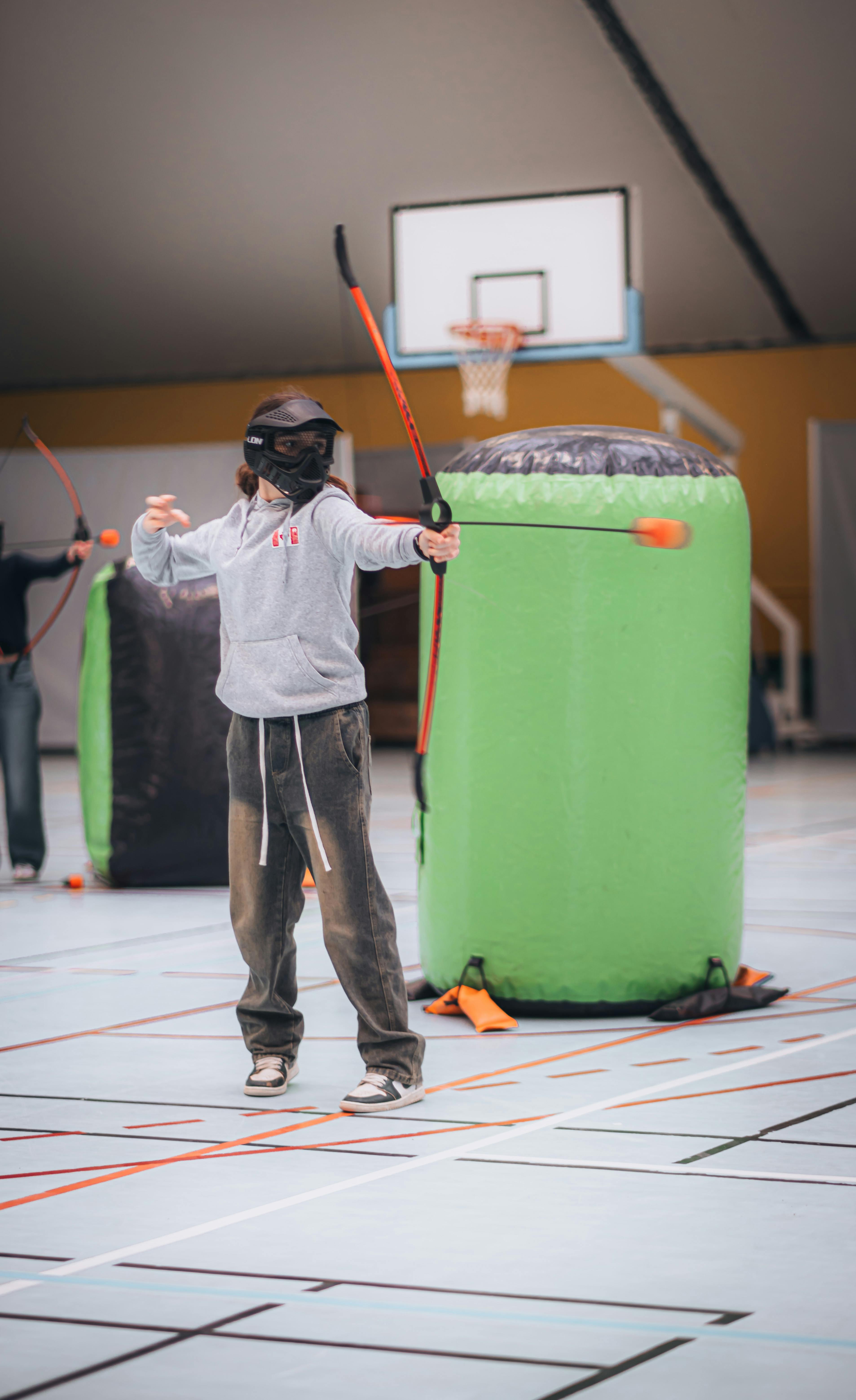 Indoor Archery Game with Inflatable Obstacles · Free Stock Photo