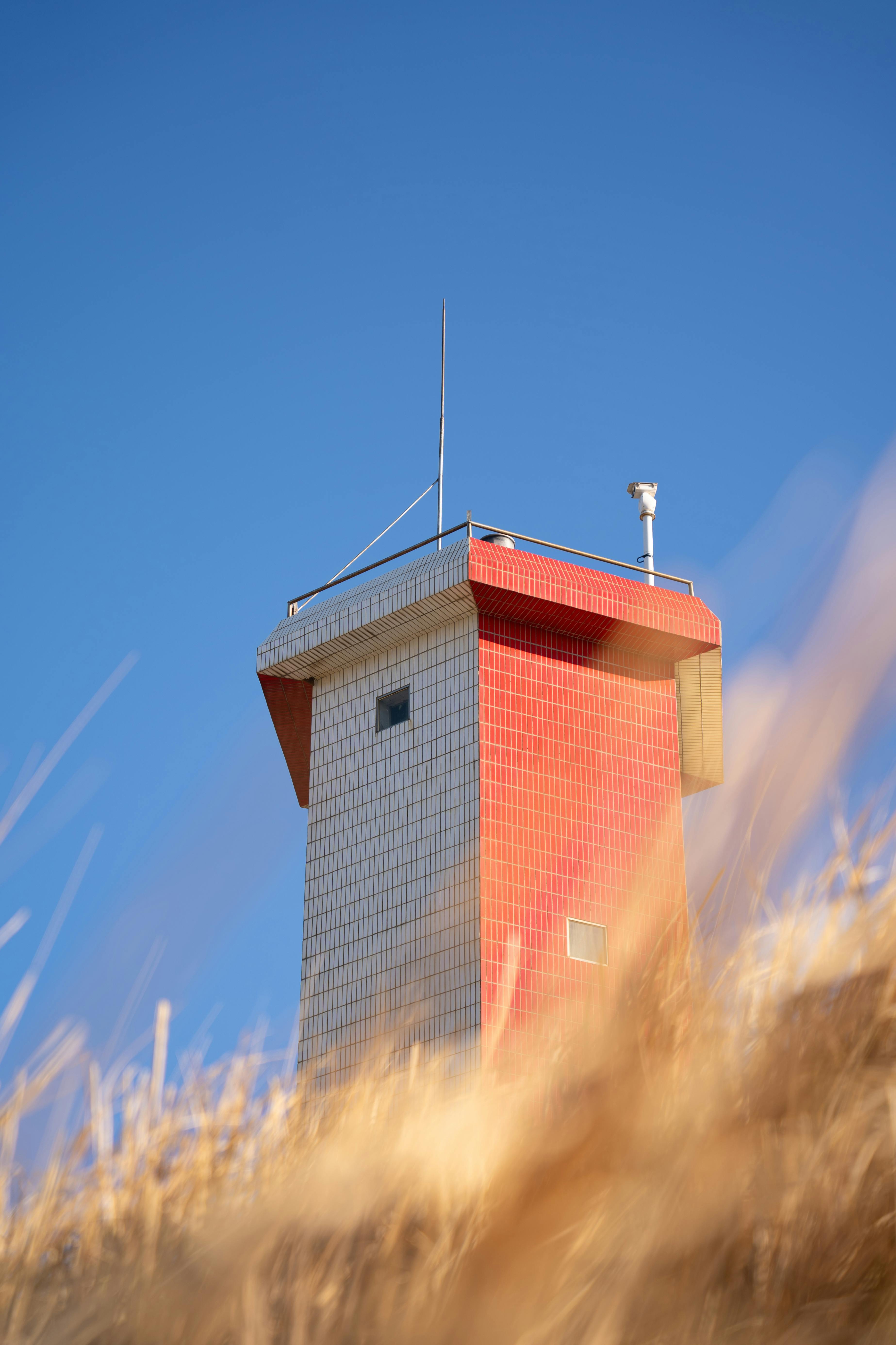 Red and White Watchtower Against Clear Blue Sky · Free Stock Photo