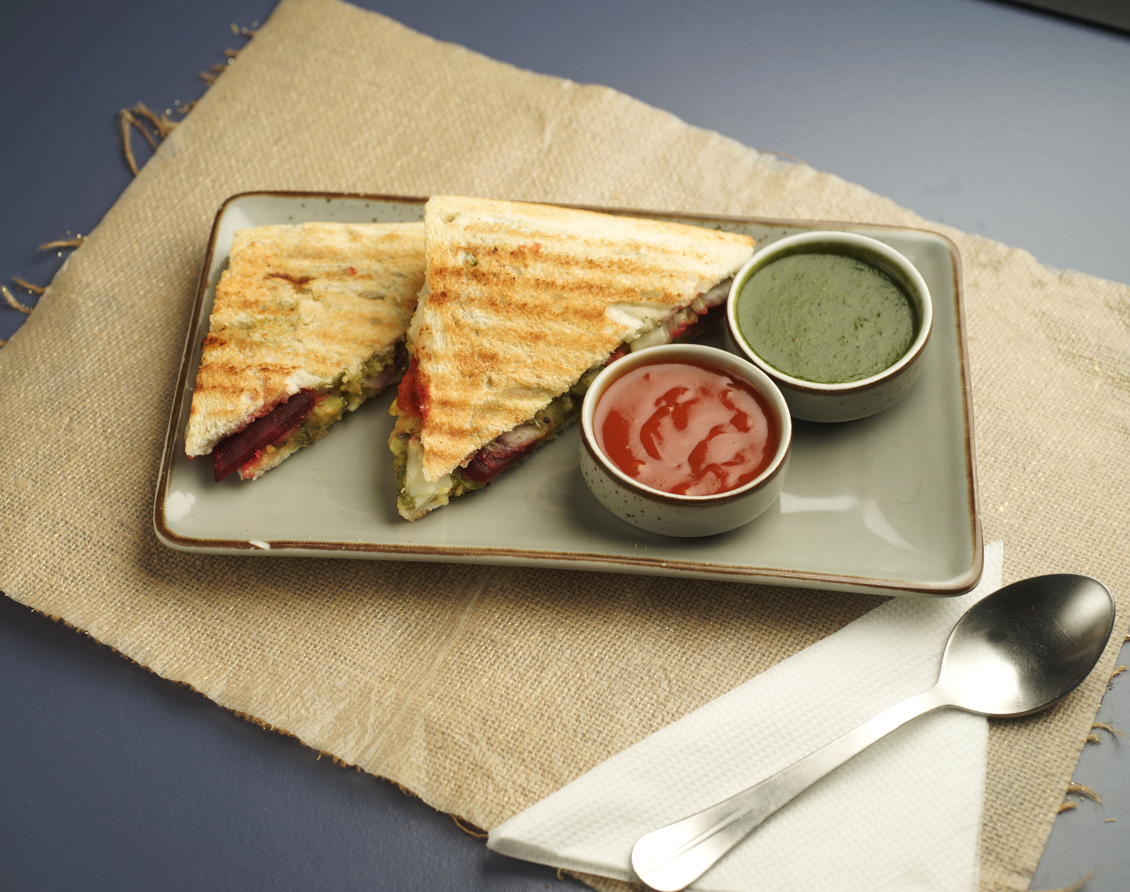 Grilled Sandwich with Condiments on Plate · Free Stock Photo