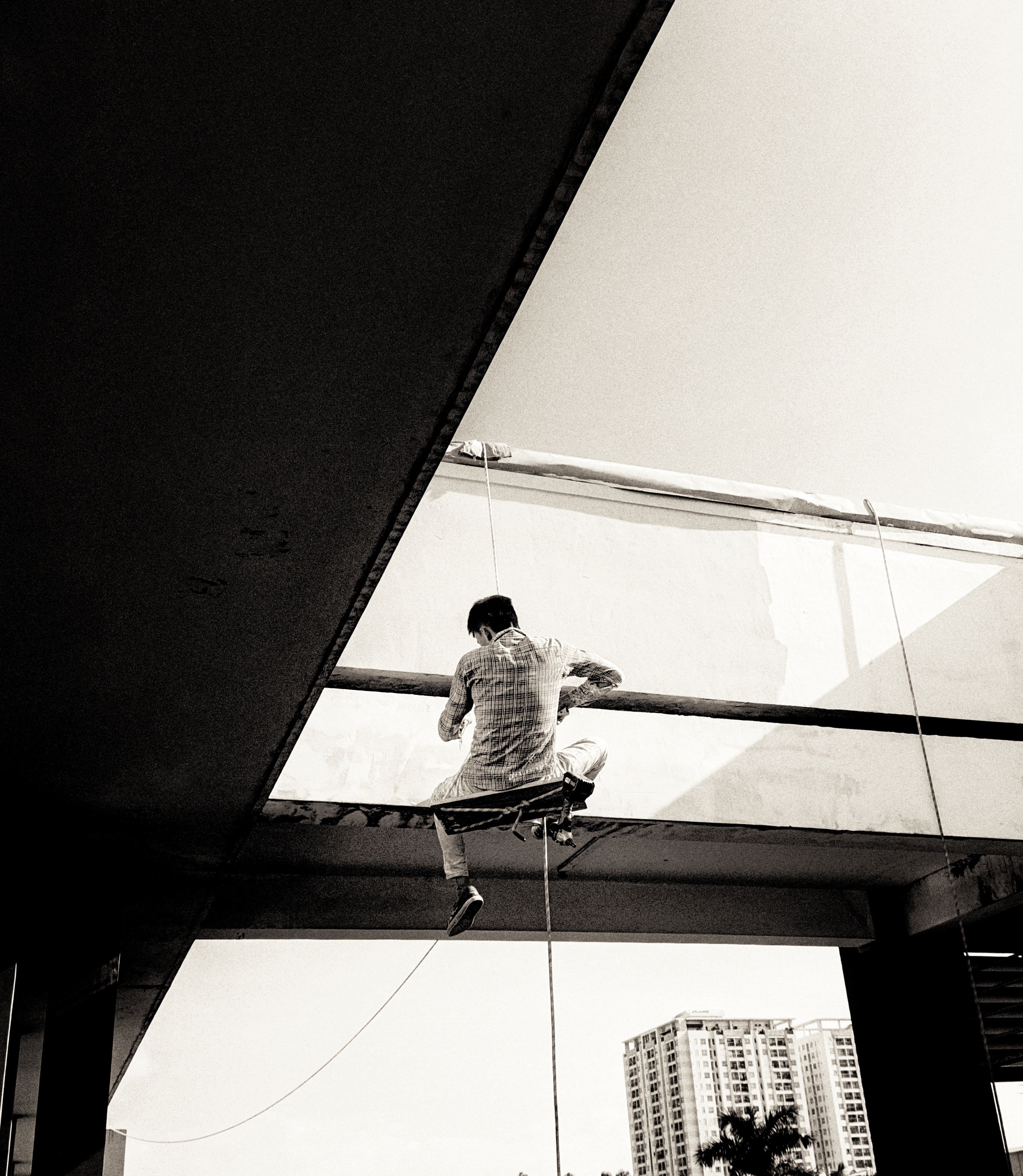 Urban Worker Suspended on High-rise Building · Free Stock Photo
