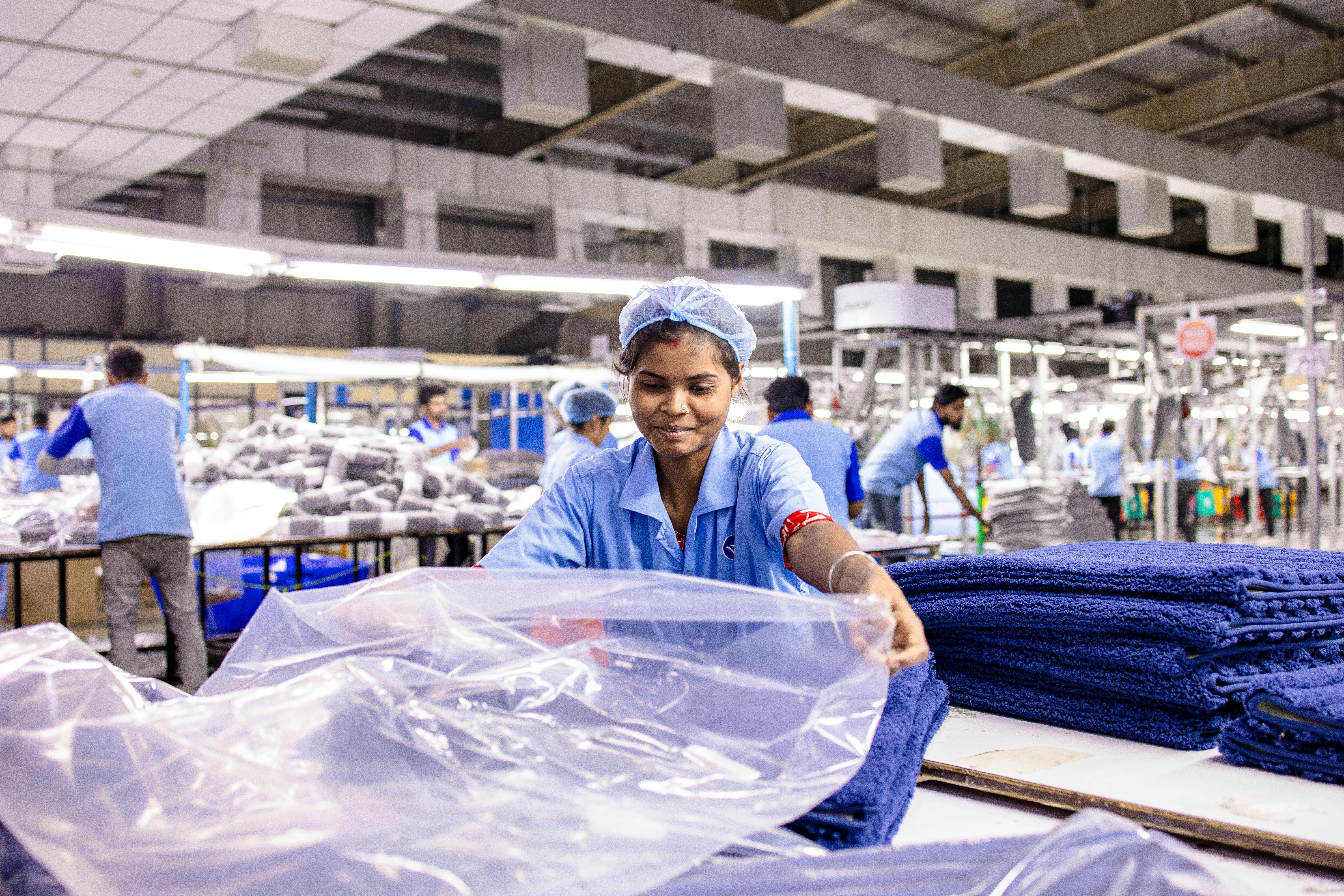 Happy Textile Workers in Modern Factory Setting · Free Stock Photo