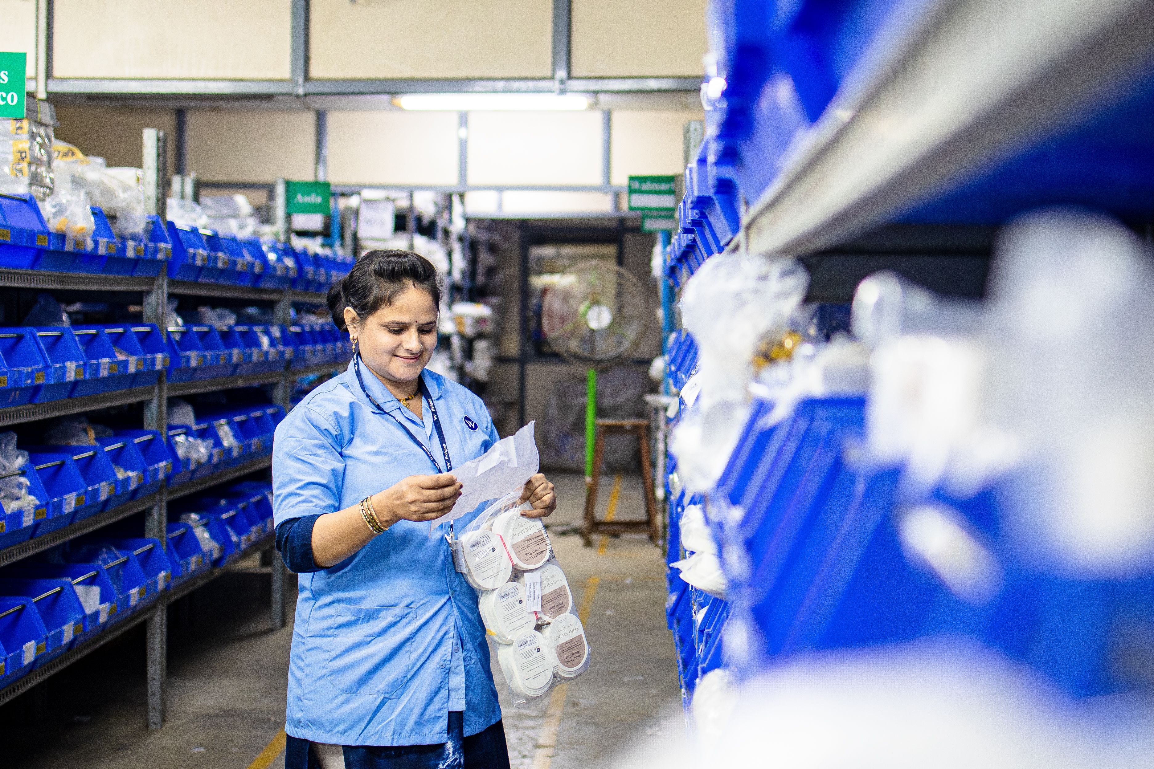 Female Worker Organizing Warehouse Inventory · Free Stock Photo