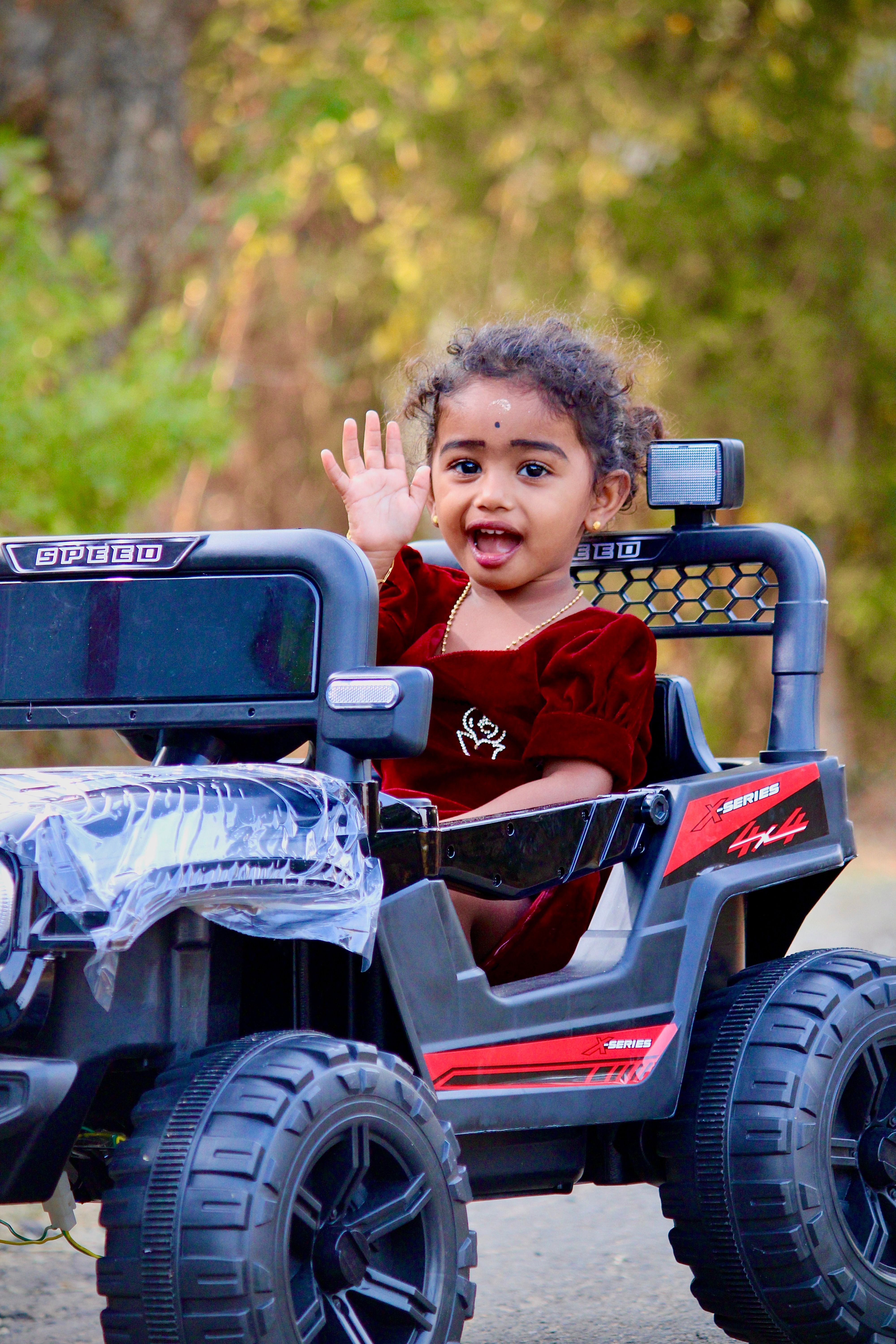 Cheerful Baby in Toy Car Outdoors · Free Stock Photo