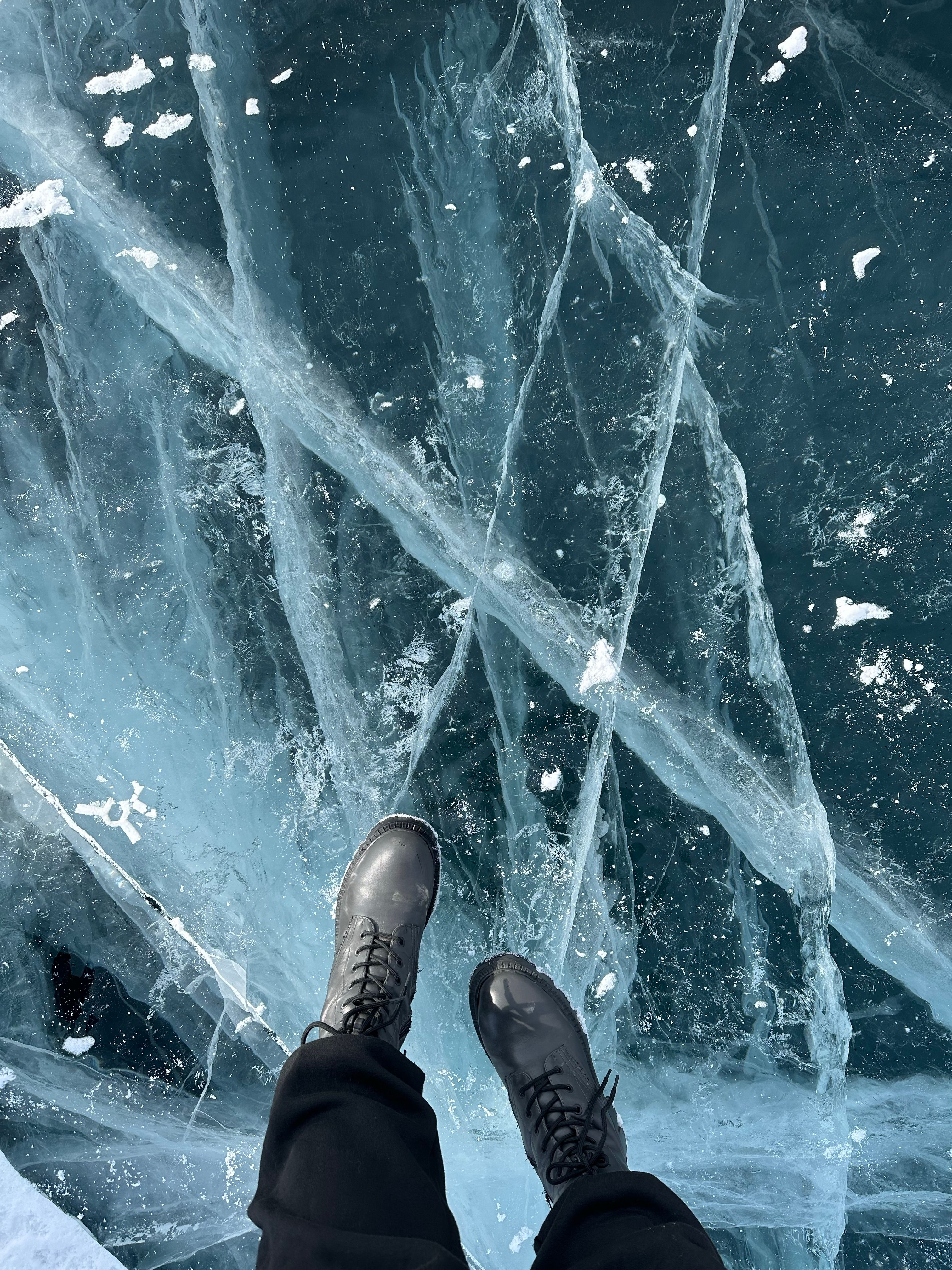 Person standing on clear frozen ice surface outdoors · Free Stock Photo