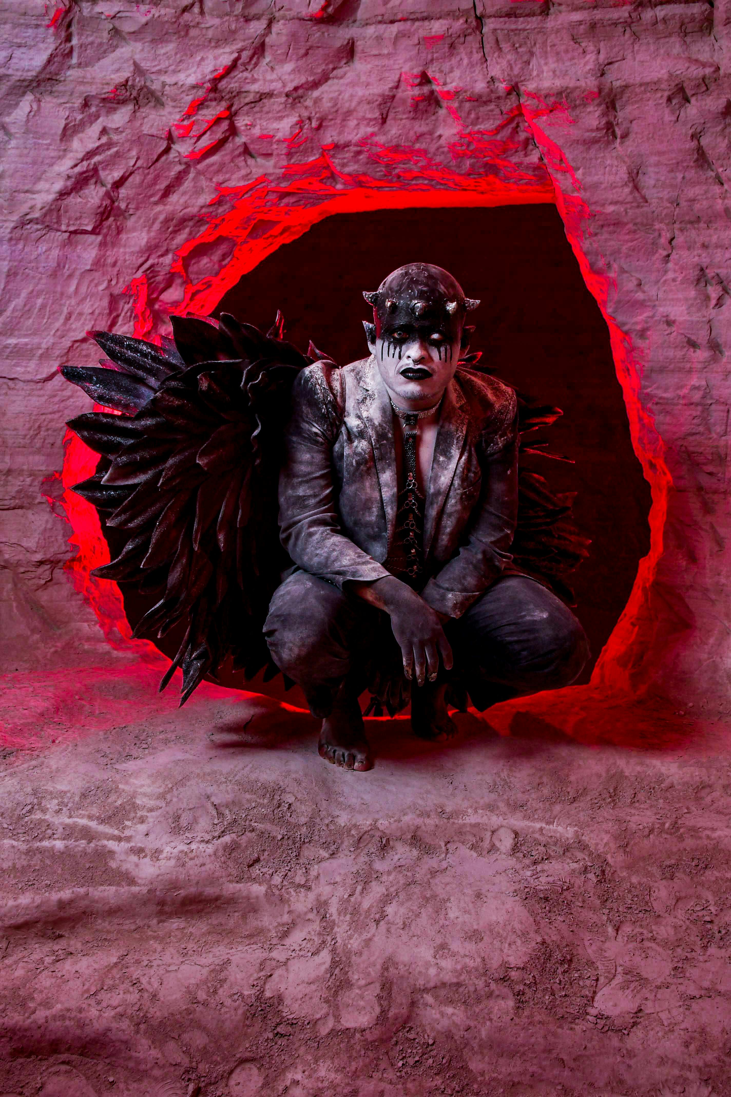 Fantasy Creature Crouching in Red Cave Opening · Free Stock Photo