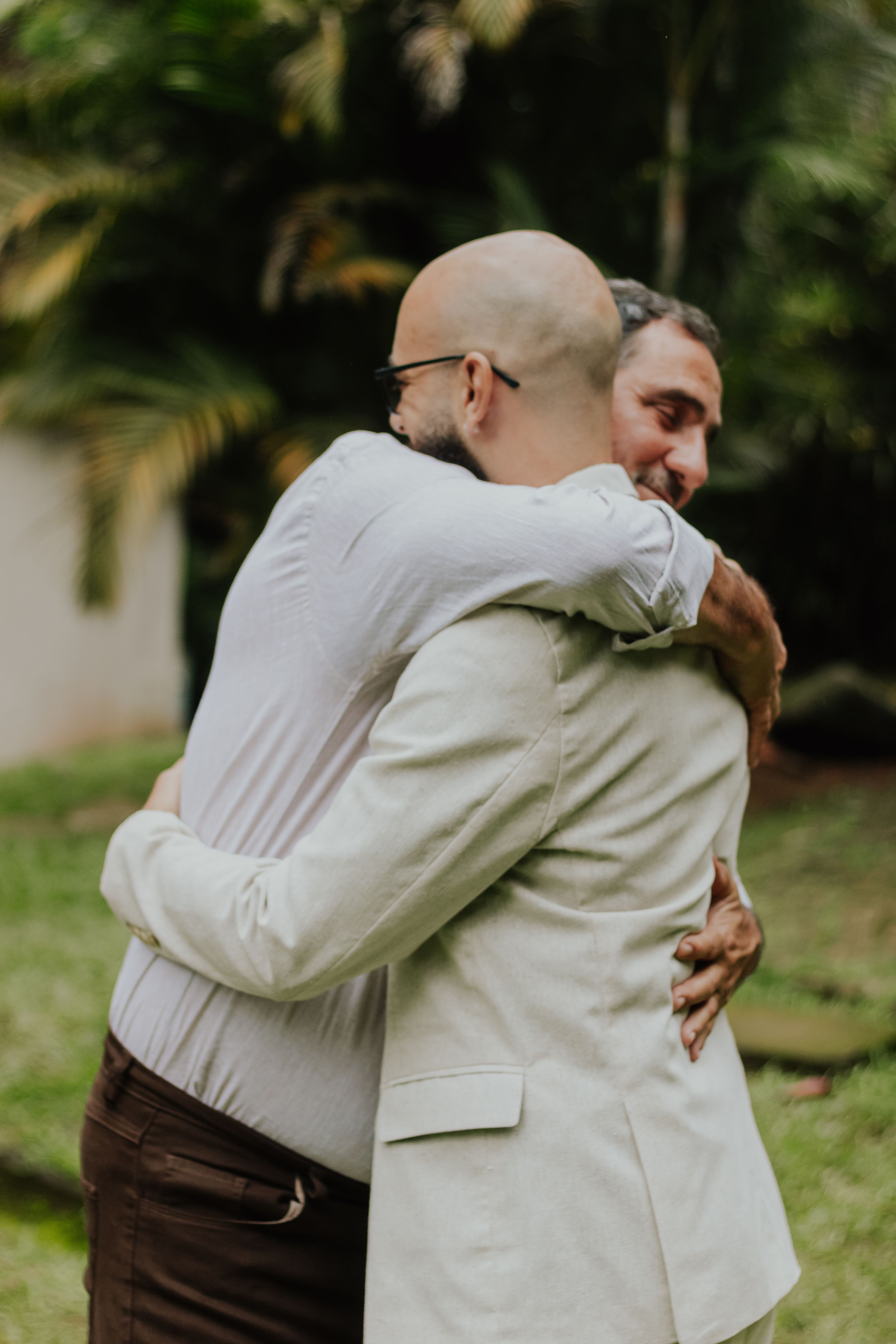 Heartfelt Embrace Between Two Men Outdoors · Free Stock Photo