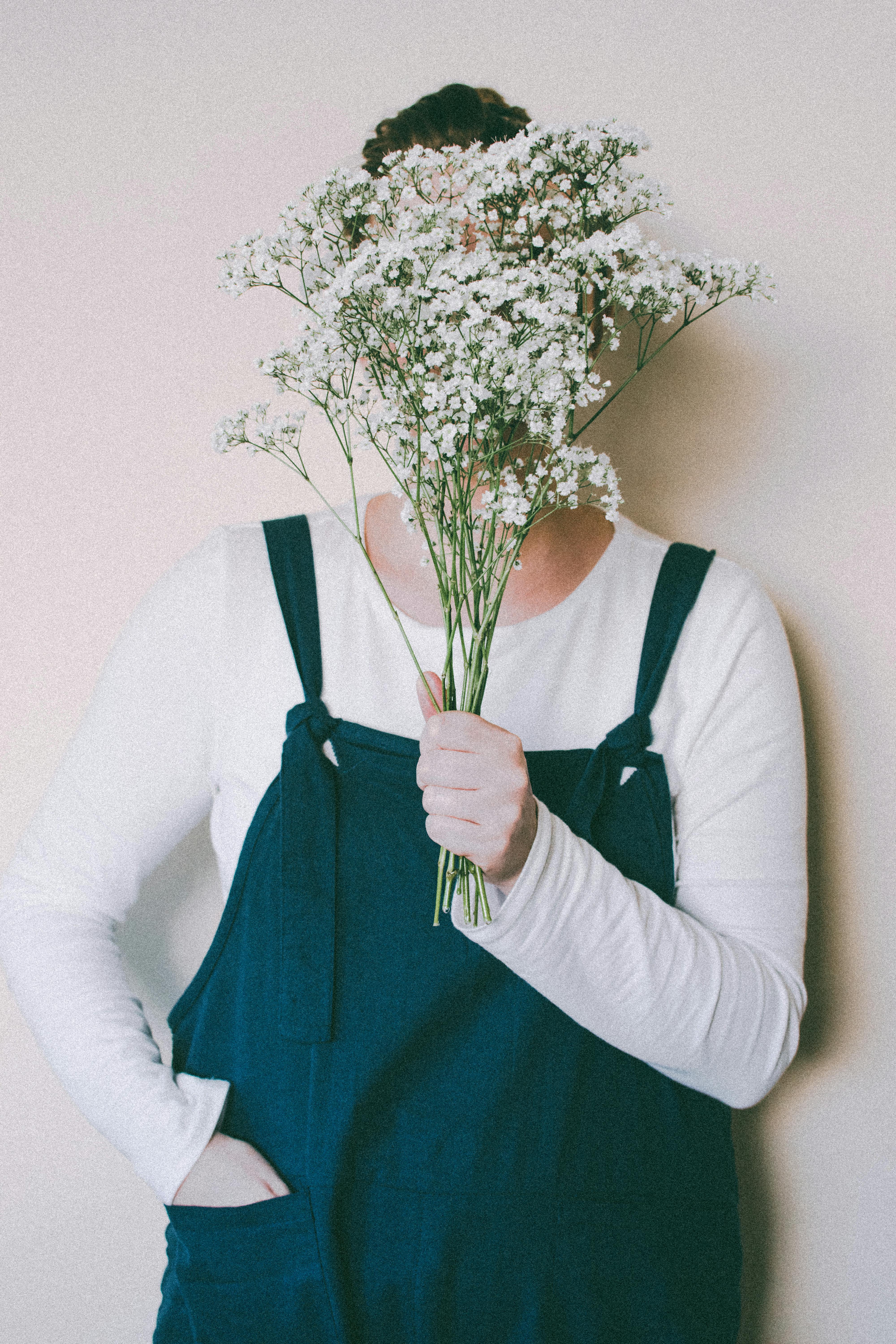 Person Hiding Face With Flowers · Free Stock Photo