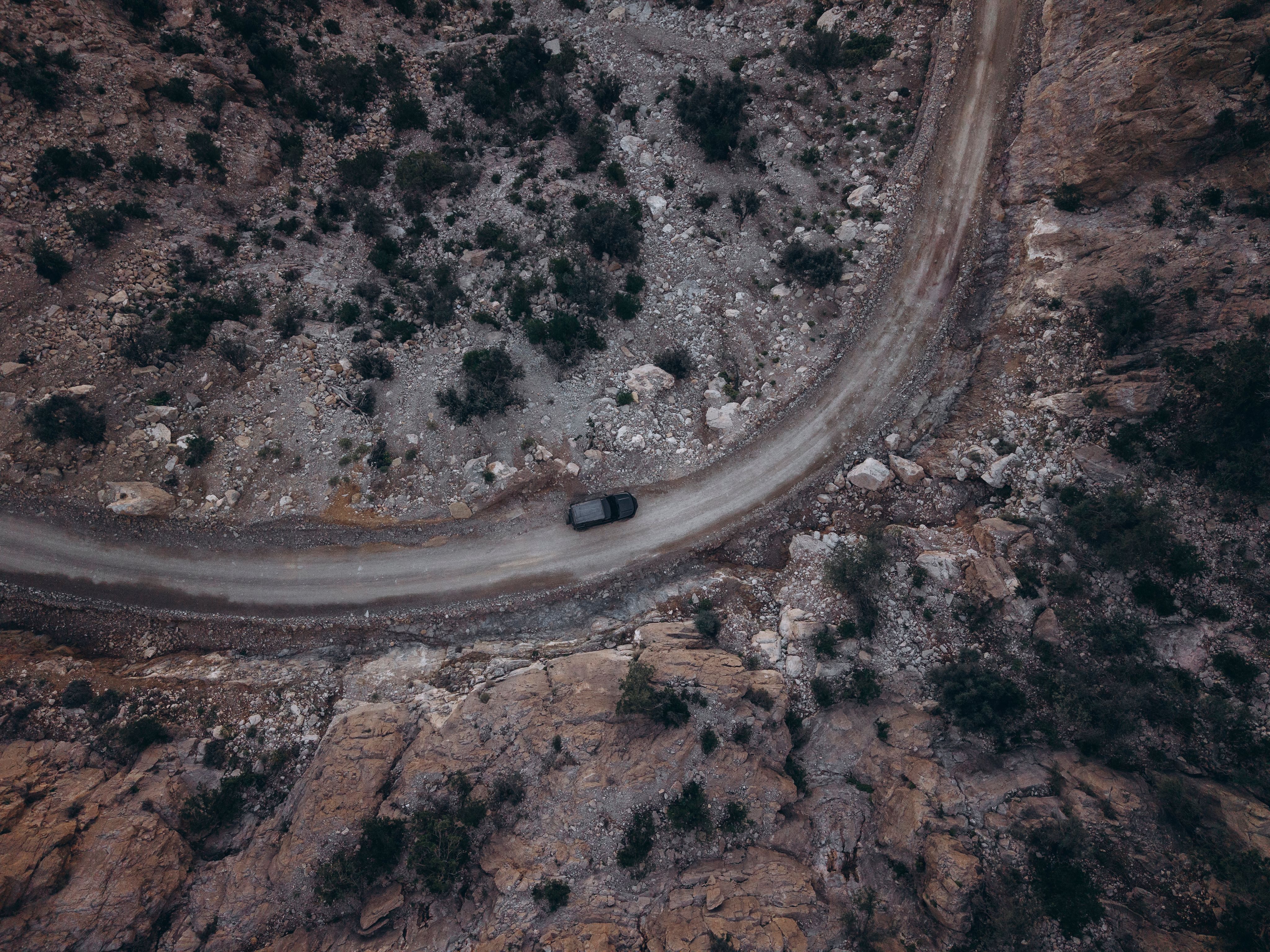 Aerial View of Off-Road Vehicle on Rocky Desert Trail · Free Stock Photo