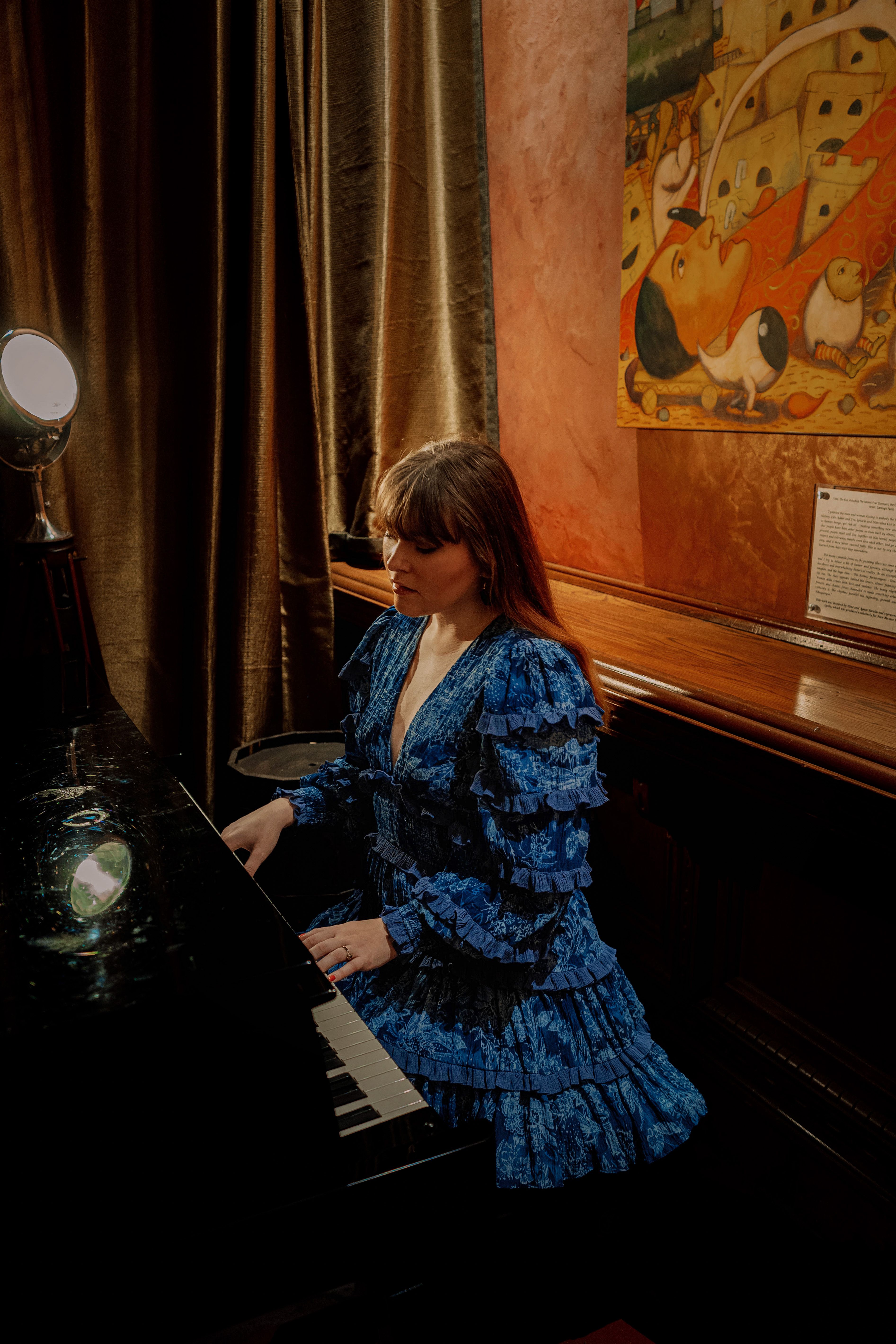 Elegant Woman in Blue Dress Playing Piano in Artistic Setting · Free ...