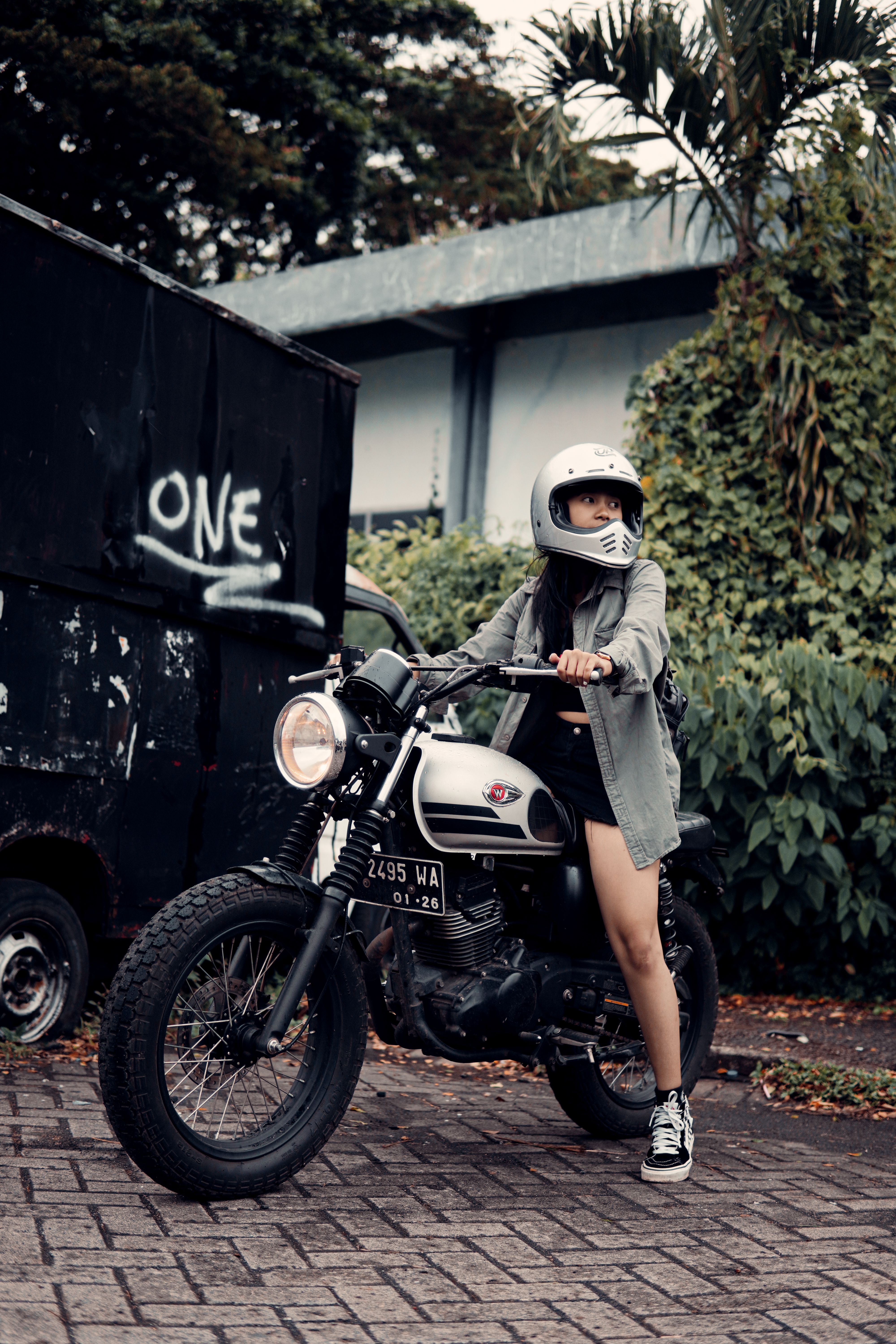 Young Woman Riding Vintage Motorcycle Outdoors · Free Stock Photo