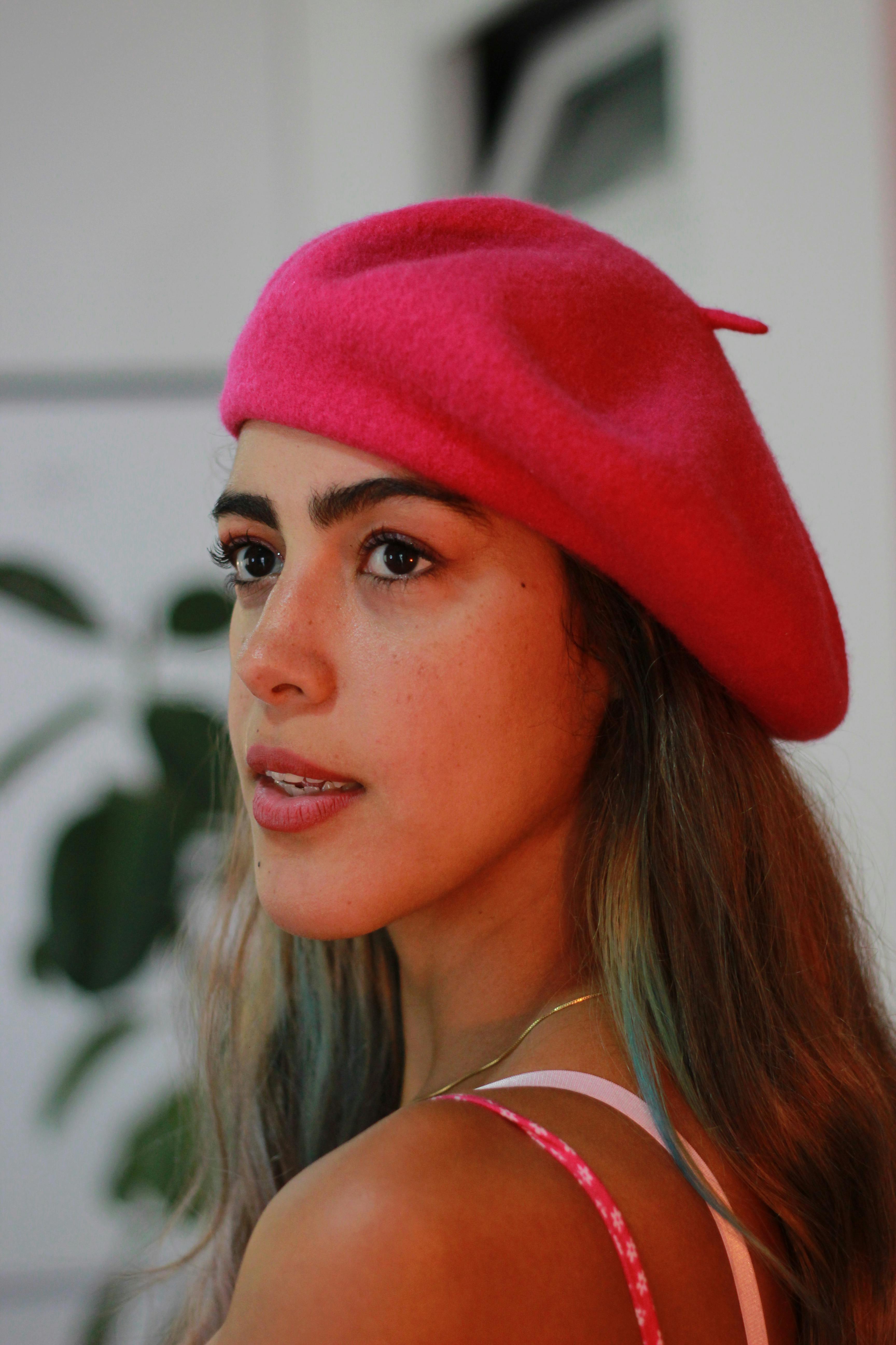Woman Wearing Pink Beret in Stylish Indoor Setting · Free Stock Photo