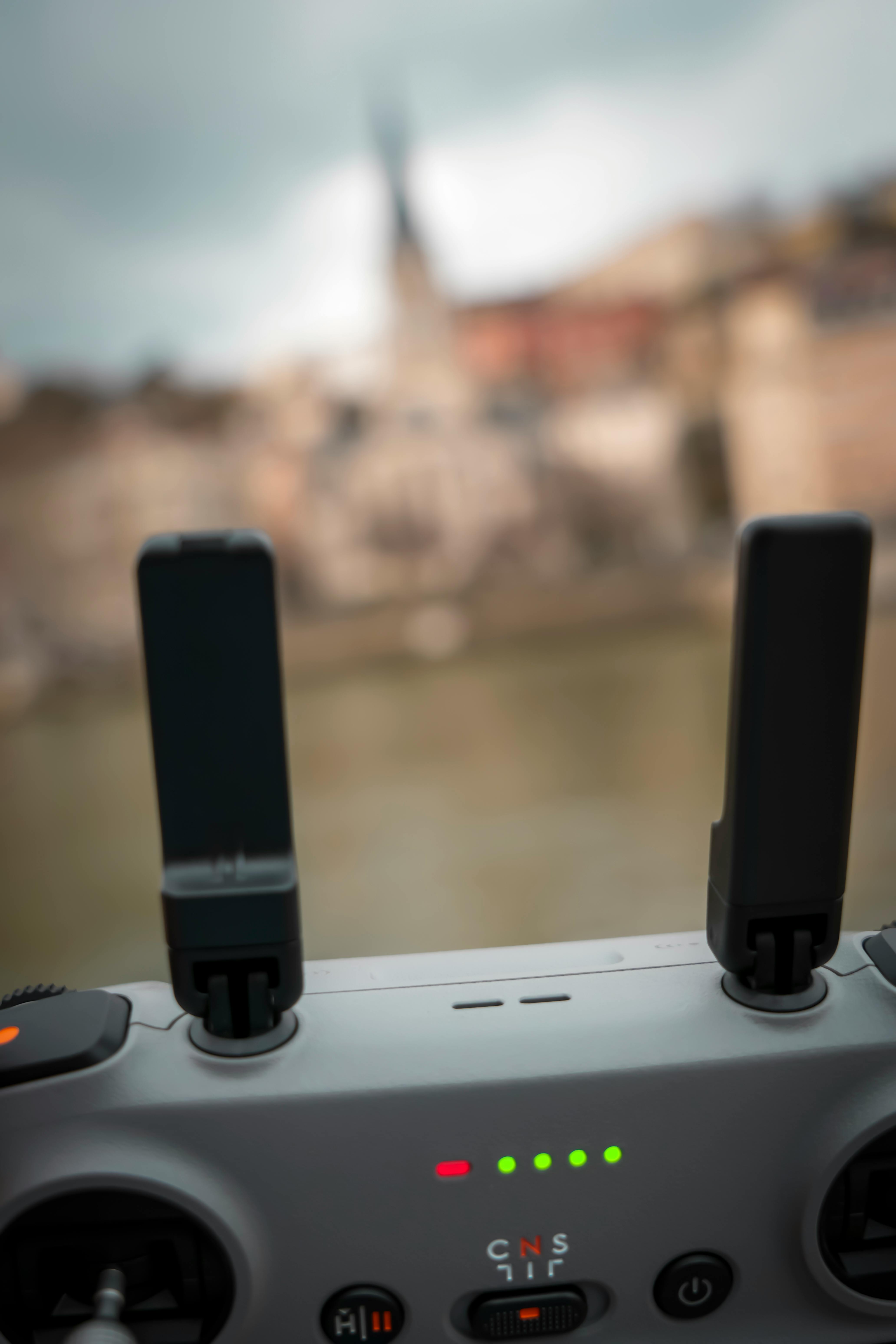 Remote Drone Controller with Blurred Cityscape · Free Stock Photo