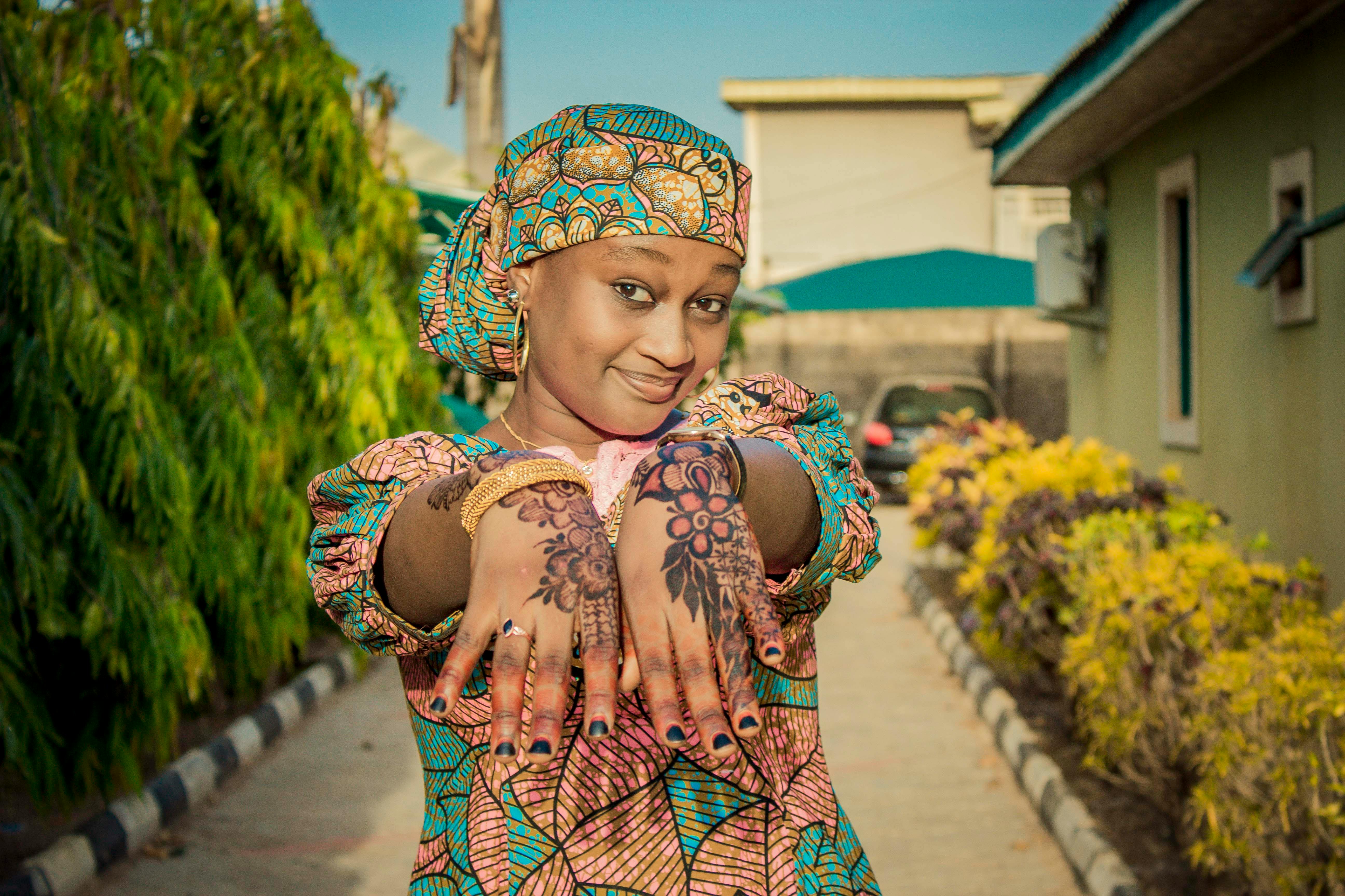 Woman Displaying Henna Art in Colorful African Attire · Free Stock Photo