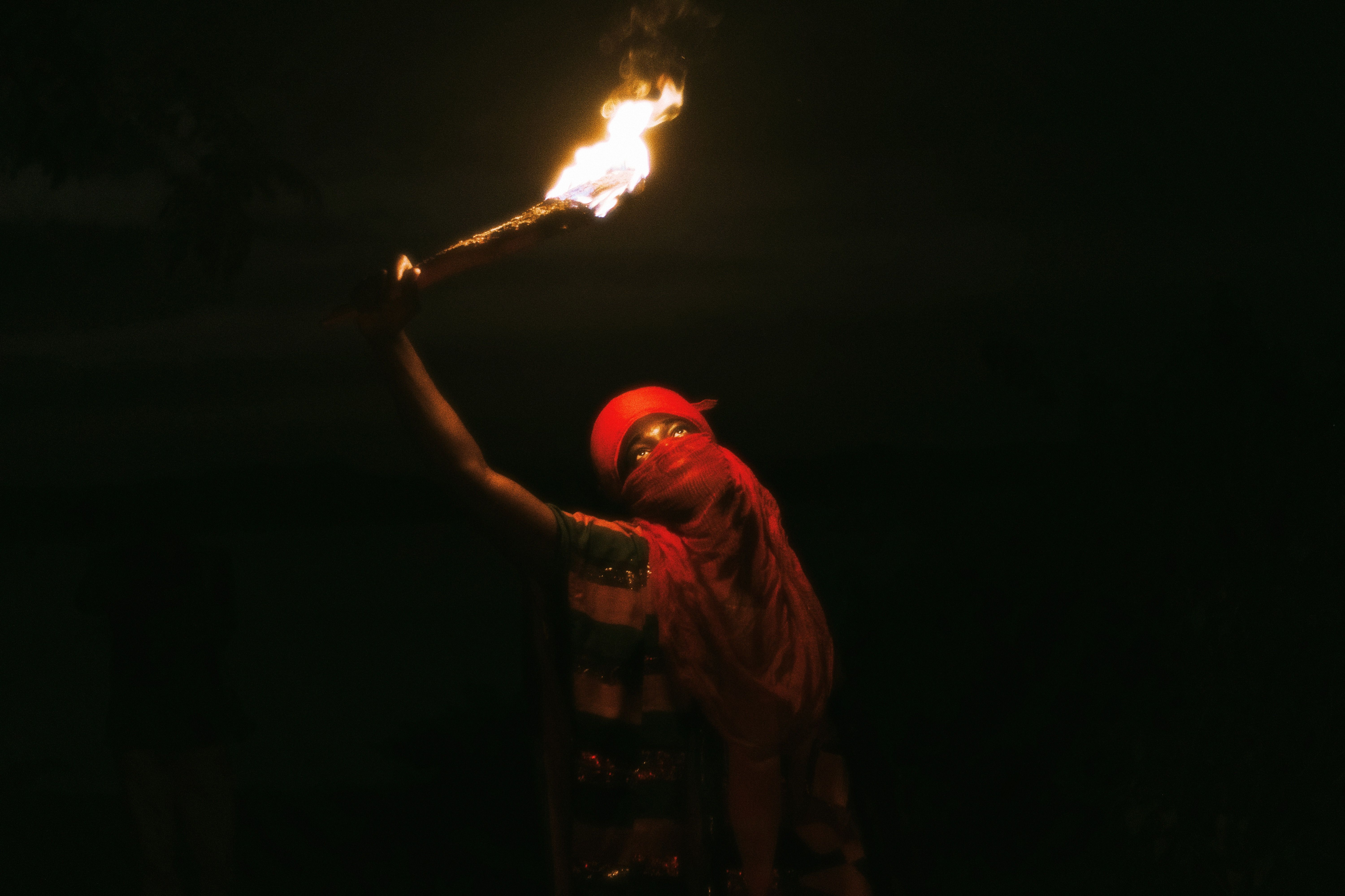Night Portrait of a Man Holding a Torch in Abuja · Free Stock Photo