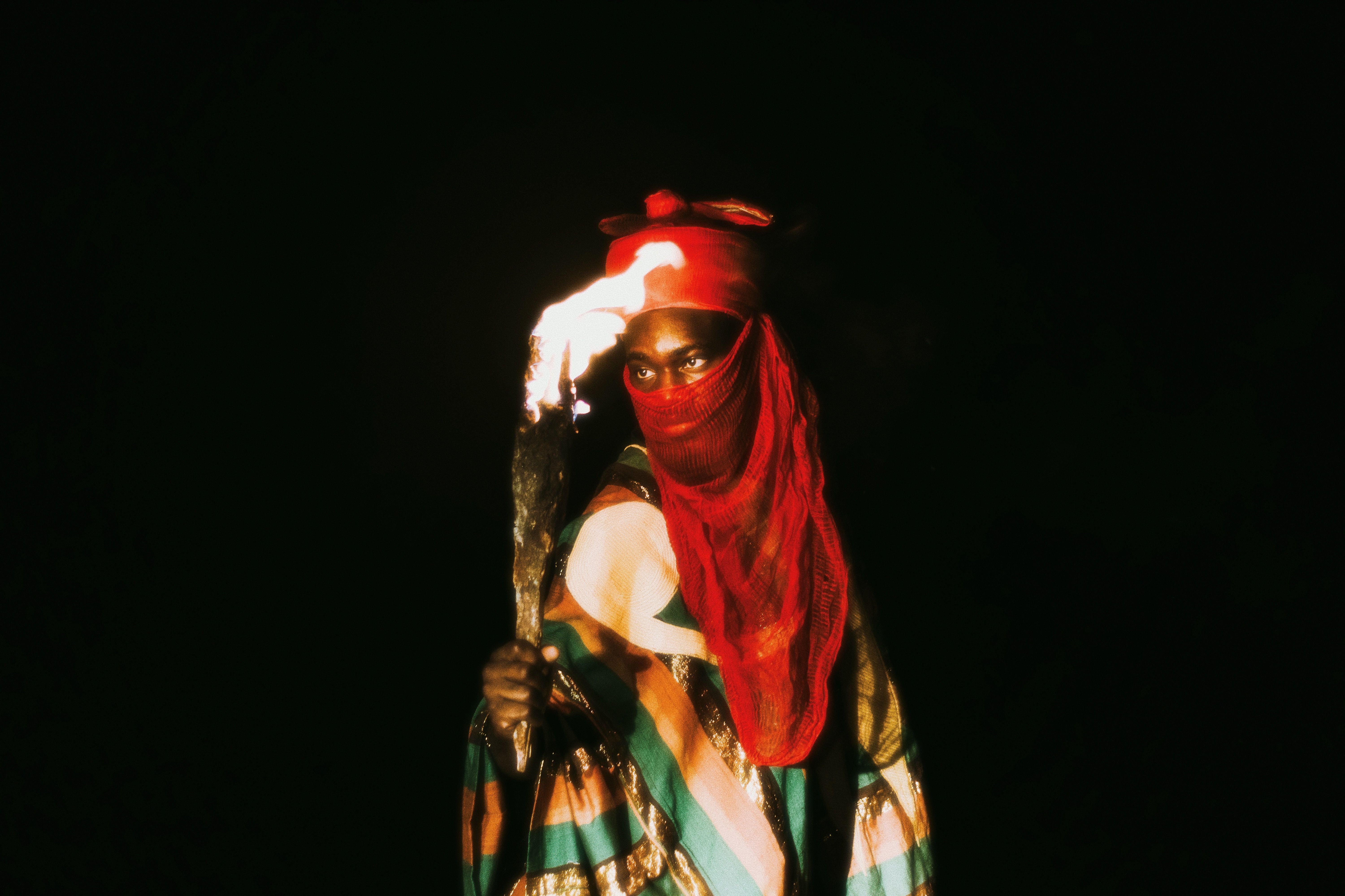 Traditional Torch Bearer in Vibrant Attire · Free Stock Photo