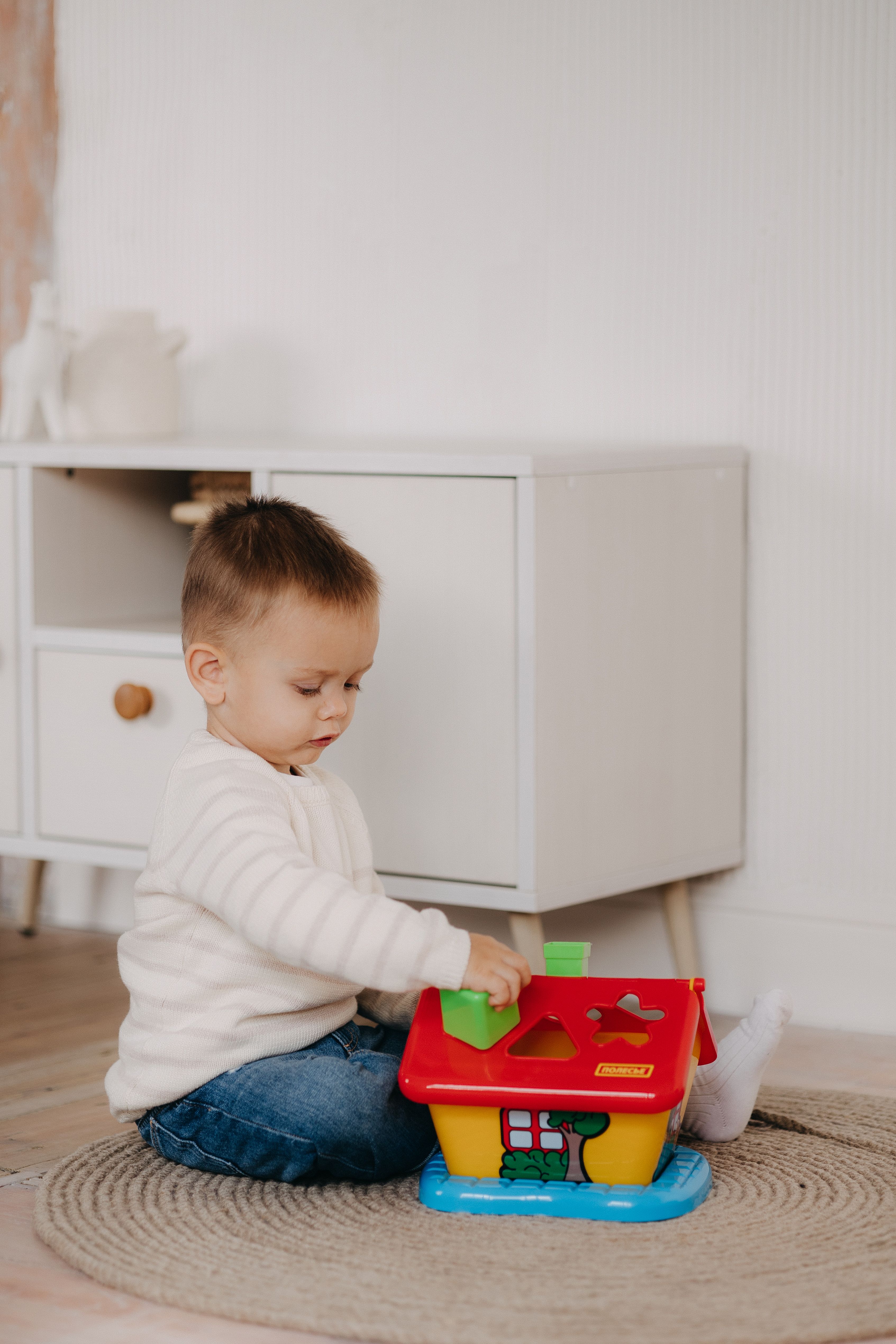Adorable Toddler Playing with Colorful Toy House · Free Stock Photo