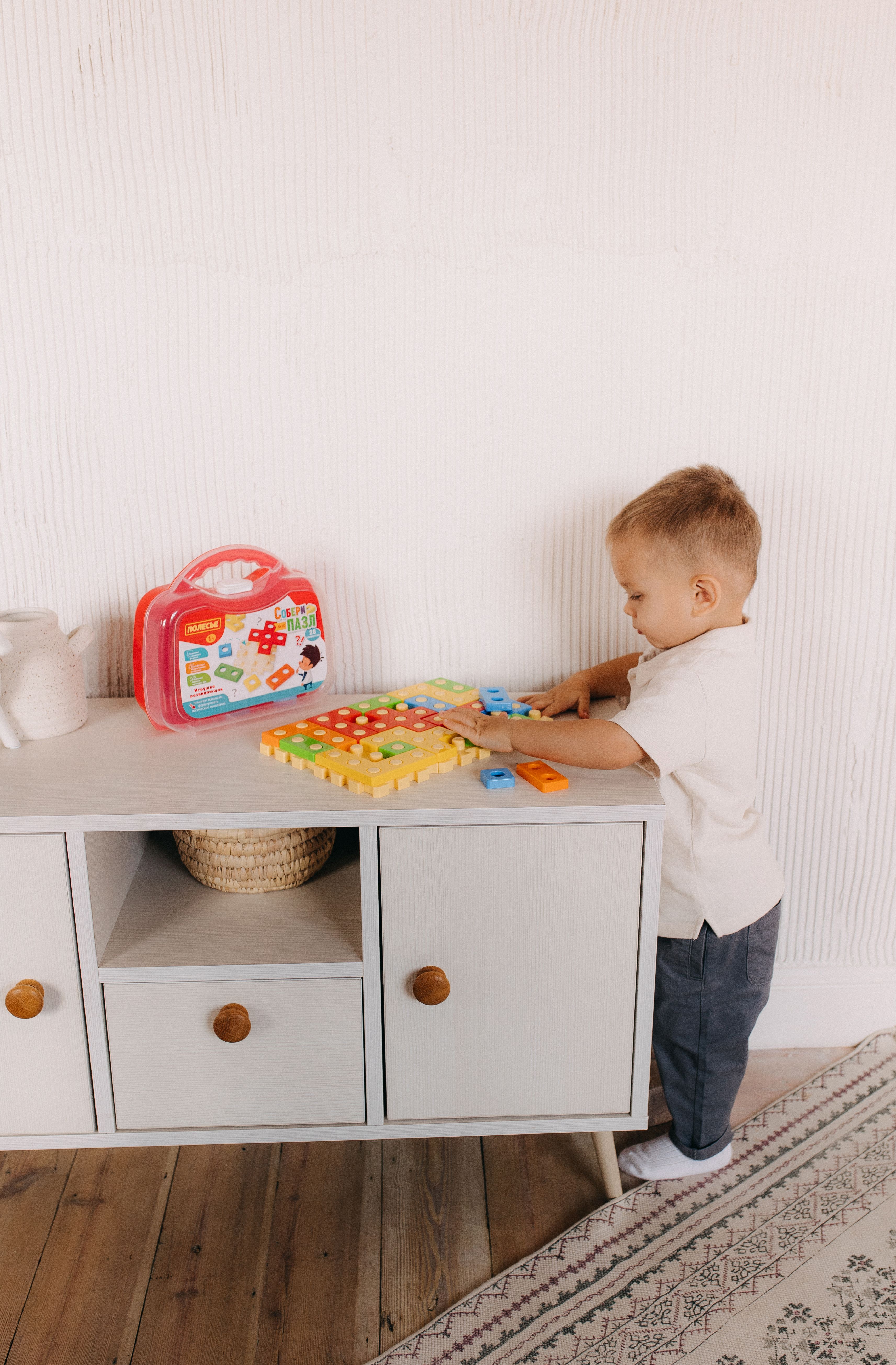Toddler Engaging with Educational Toy Indoors · Free Stock Photo