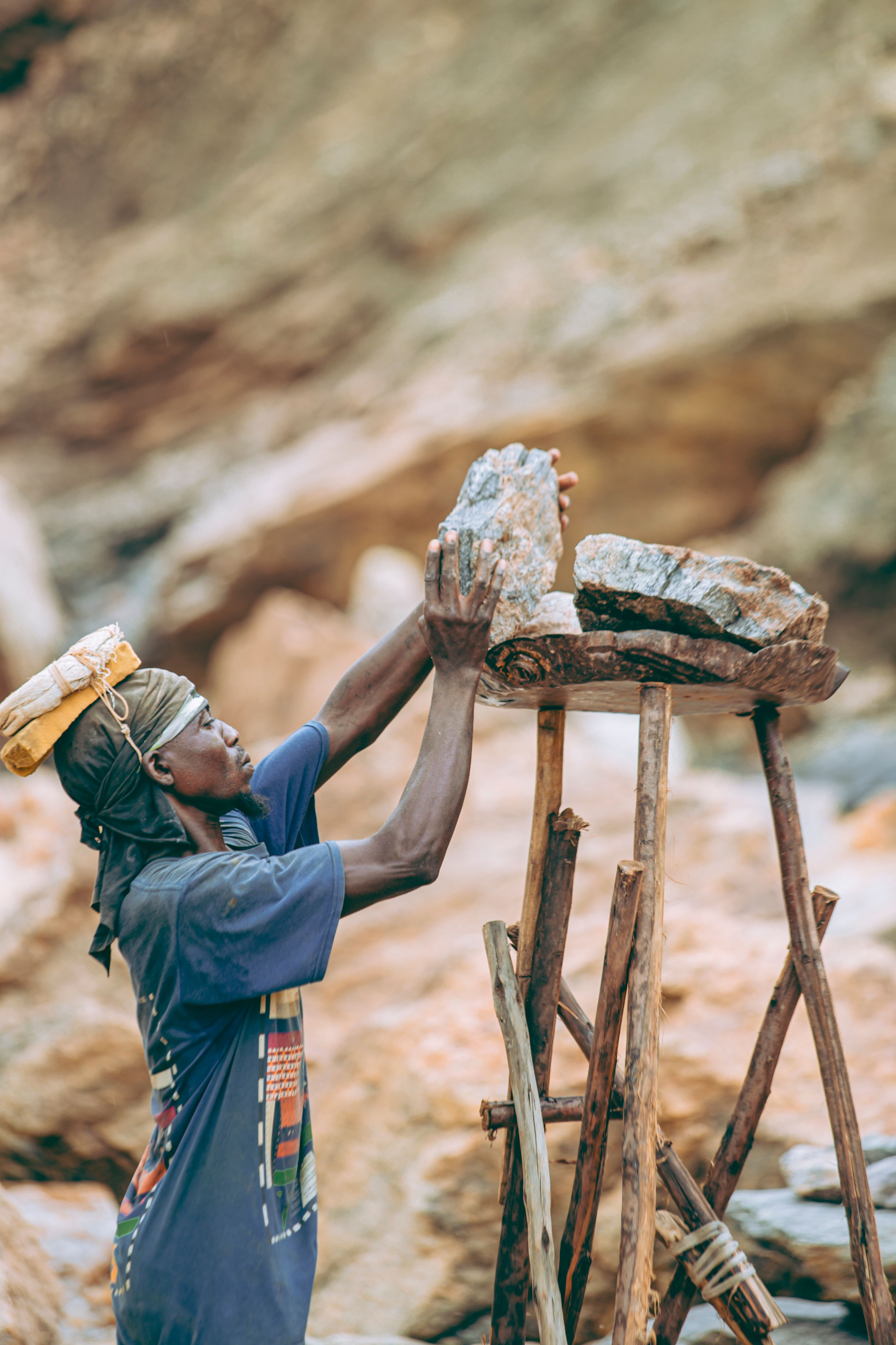 African Artisan Balancing Rocks Outdoors · Free Stock Photo