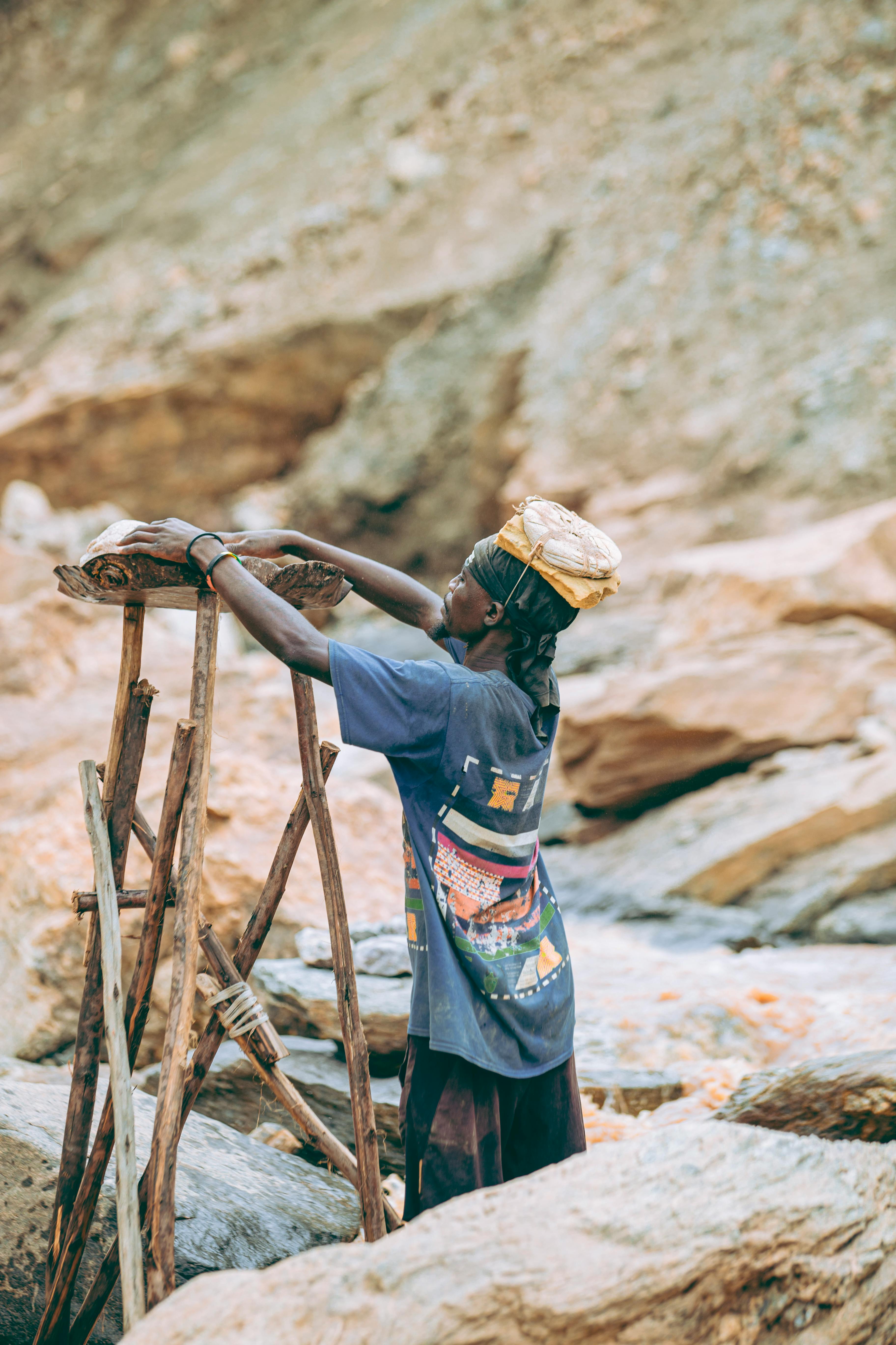 African Miner Working in a Rocky Landscape · Free Stock Photo