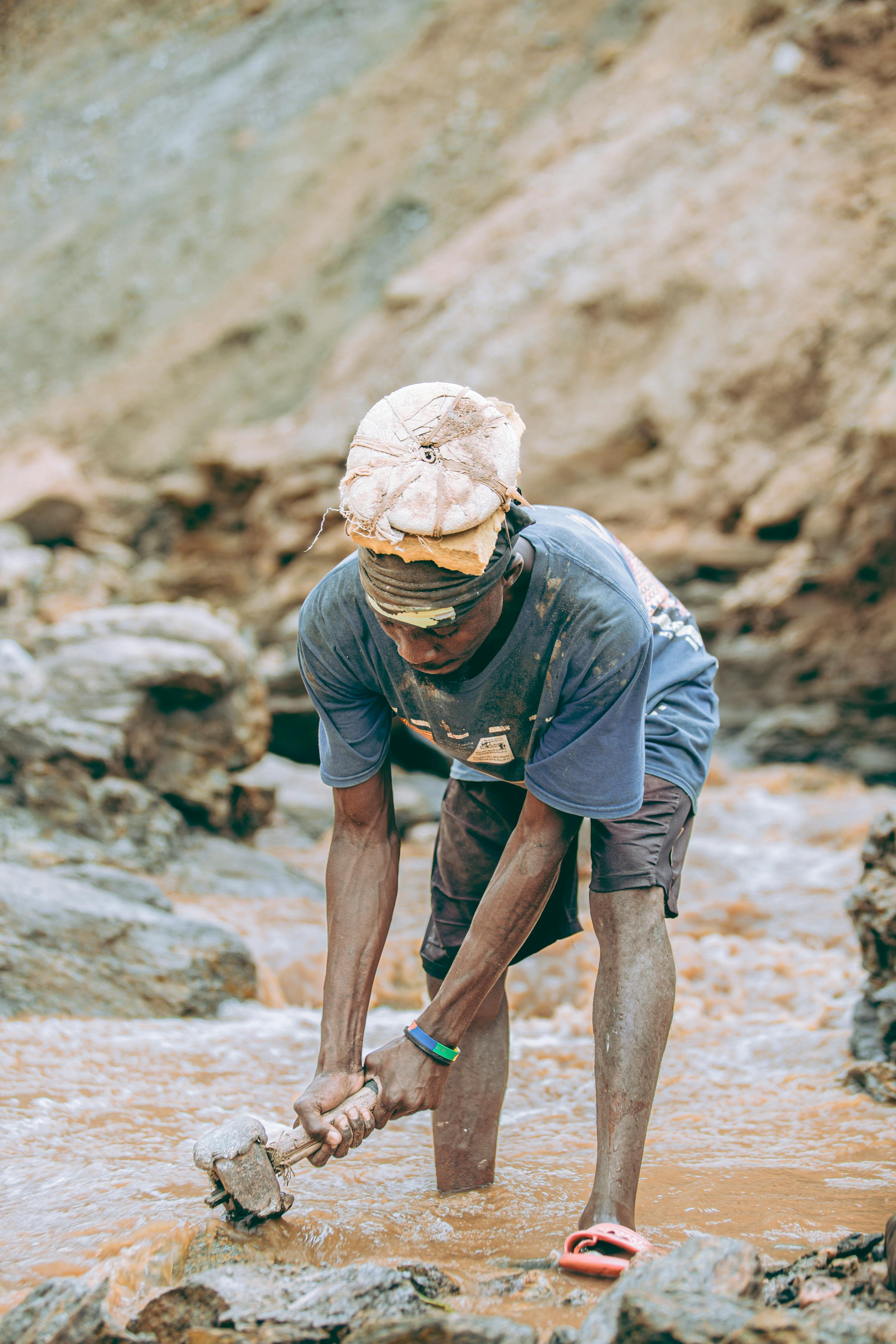 A Miner Working in a Rocky Outdoor Setting · Free Stock Photo