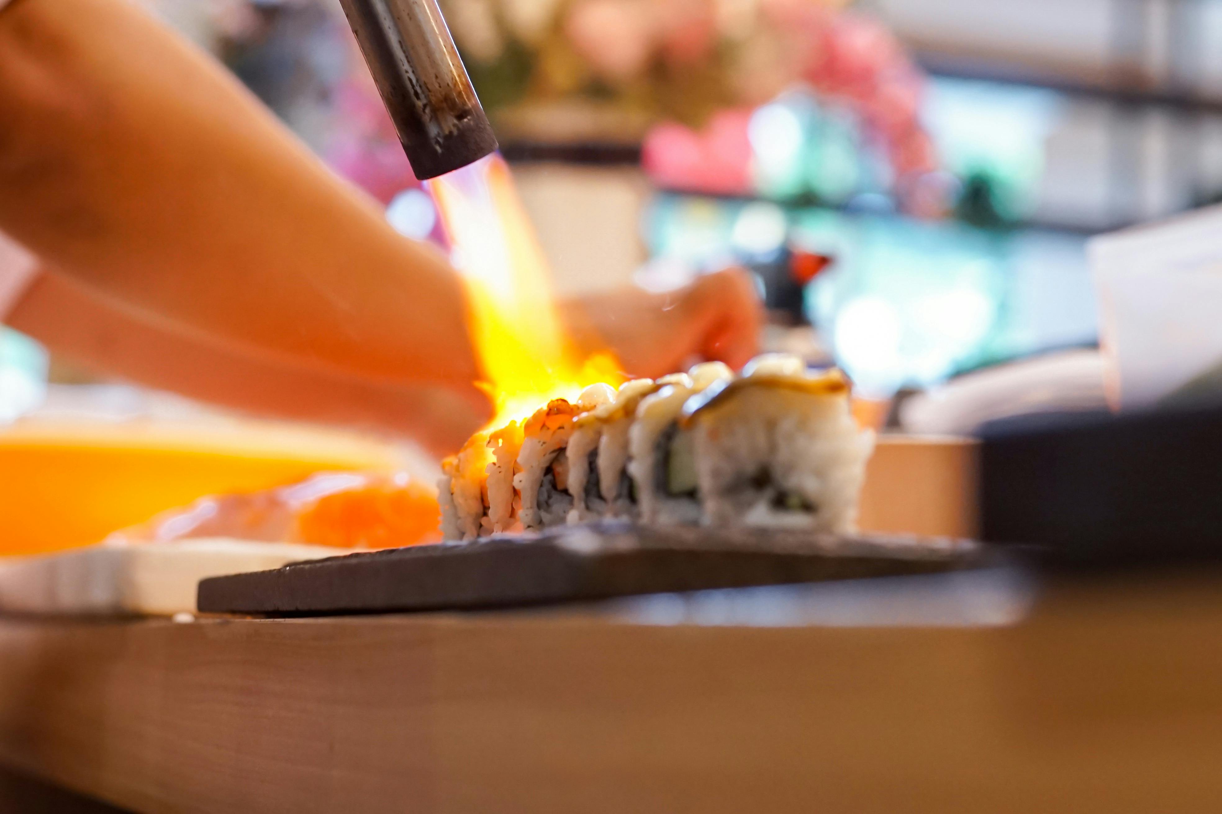 Torched Sushi Roll Preparation in Restaurant · Free Stock Photo