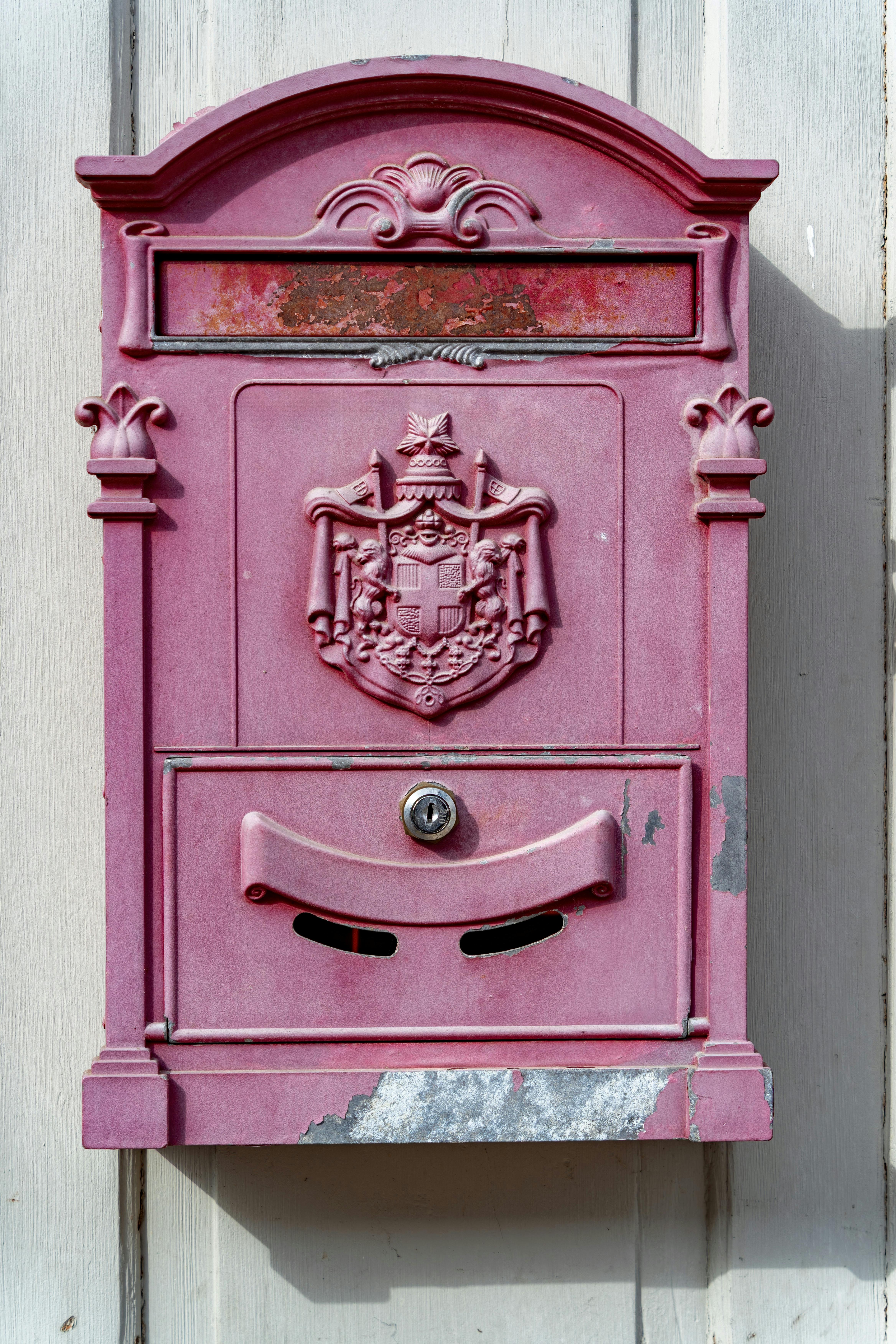 Vintage Pink Cast Iron Mailbox with Crest · Free Stock Photo