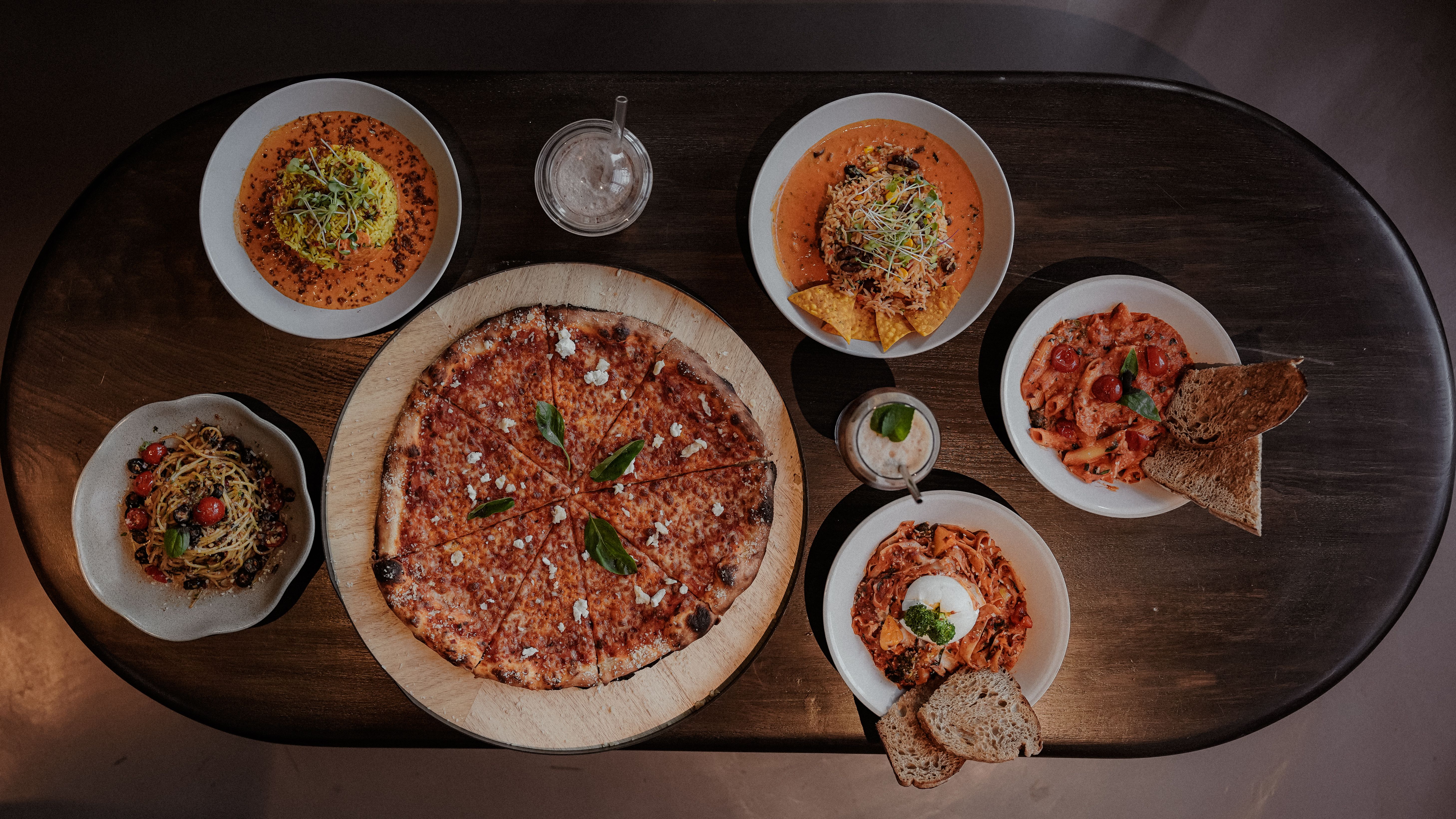 Delicious Italian Feast with Pizza and Pasta · Free Stock Photo