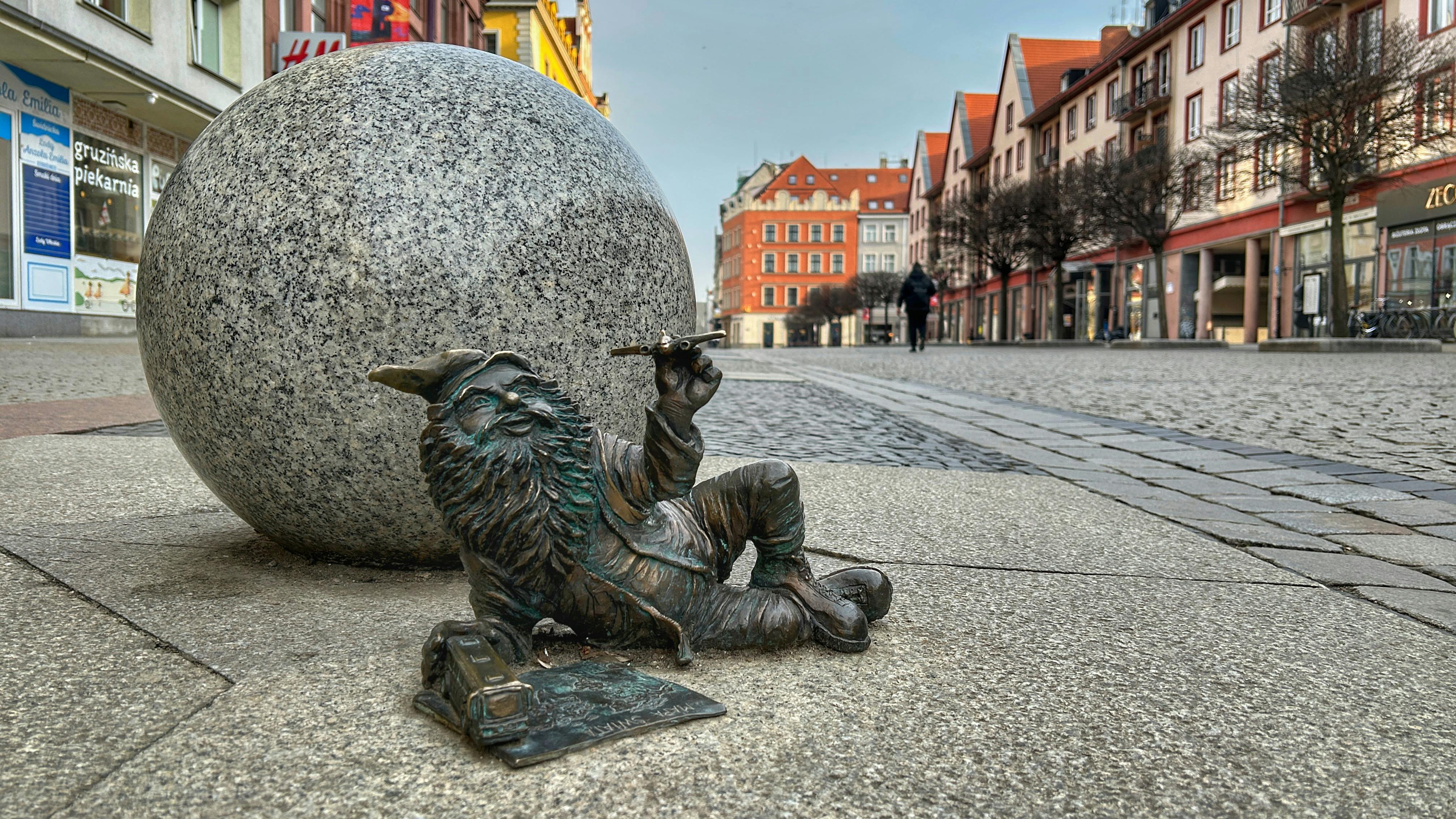 Wrocław Dwarf Statue and Cobblestone Street Scene · Free Stock Photo